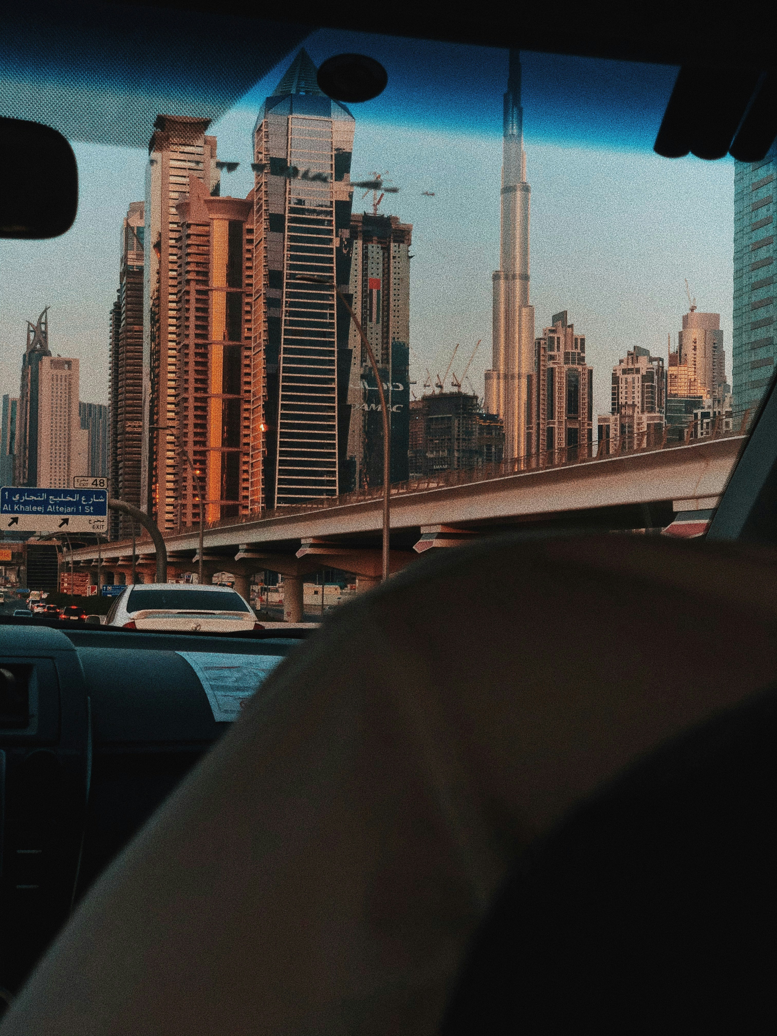 Glass Giants Rising: Dubai Skyline Framed by a Rush-Hour Car Window