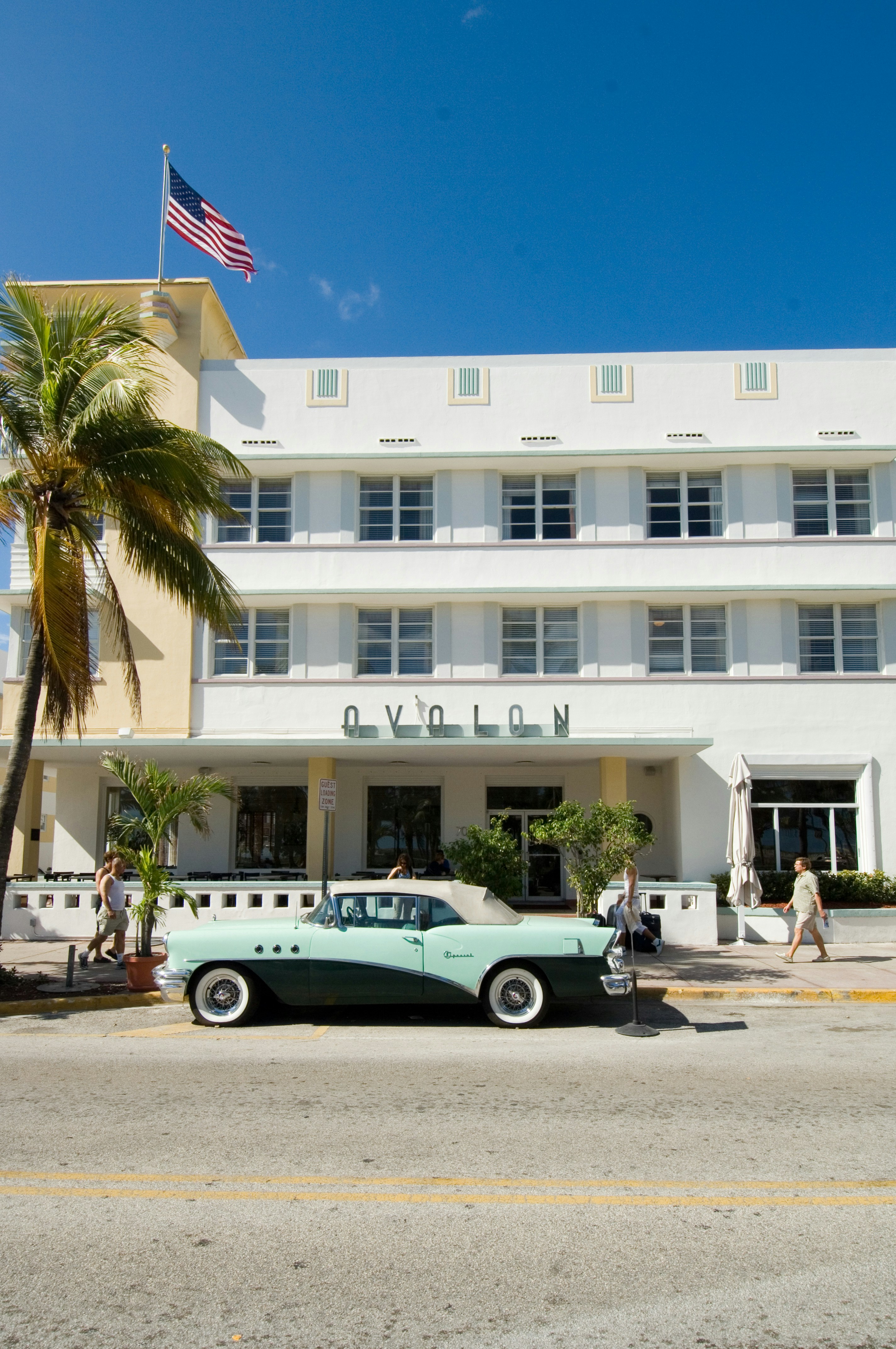 Pastel Convertible in Front of a Coastal Hotel