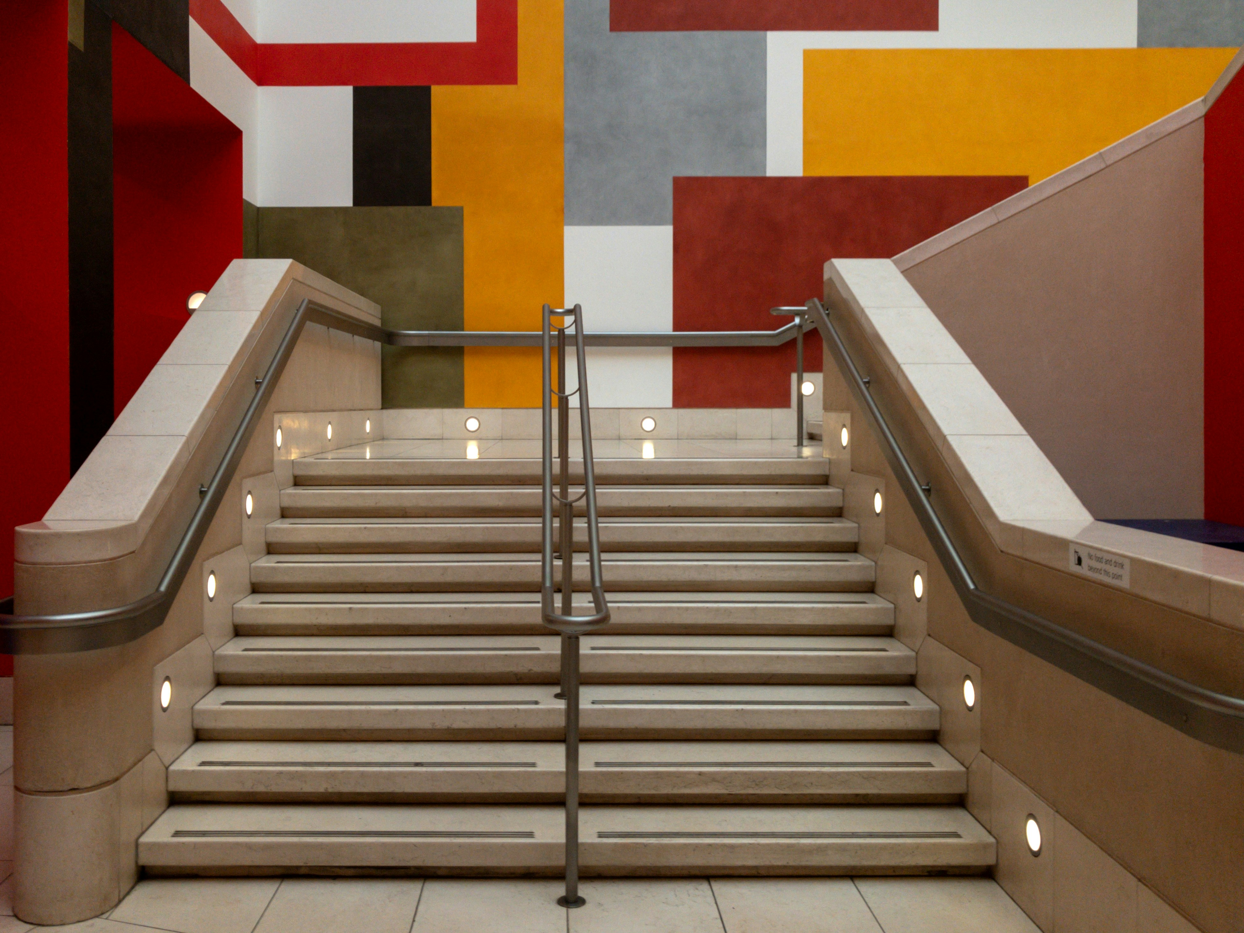 Stainless steel hand rail on white and red concrete staircase photo ...