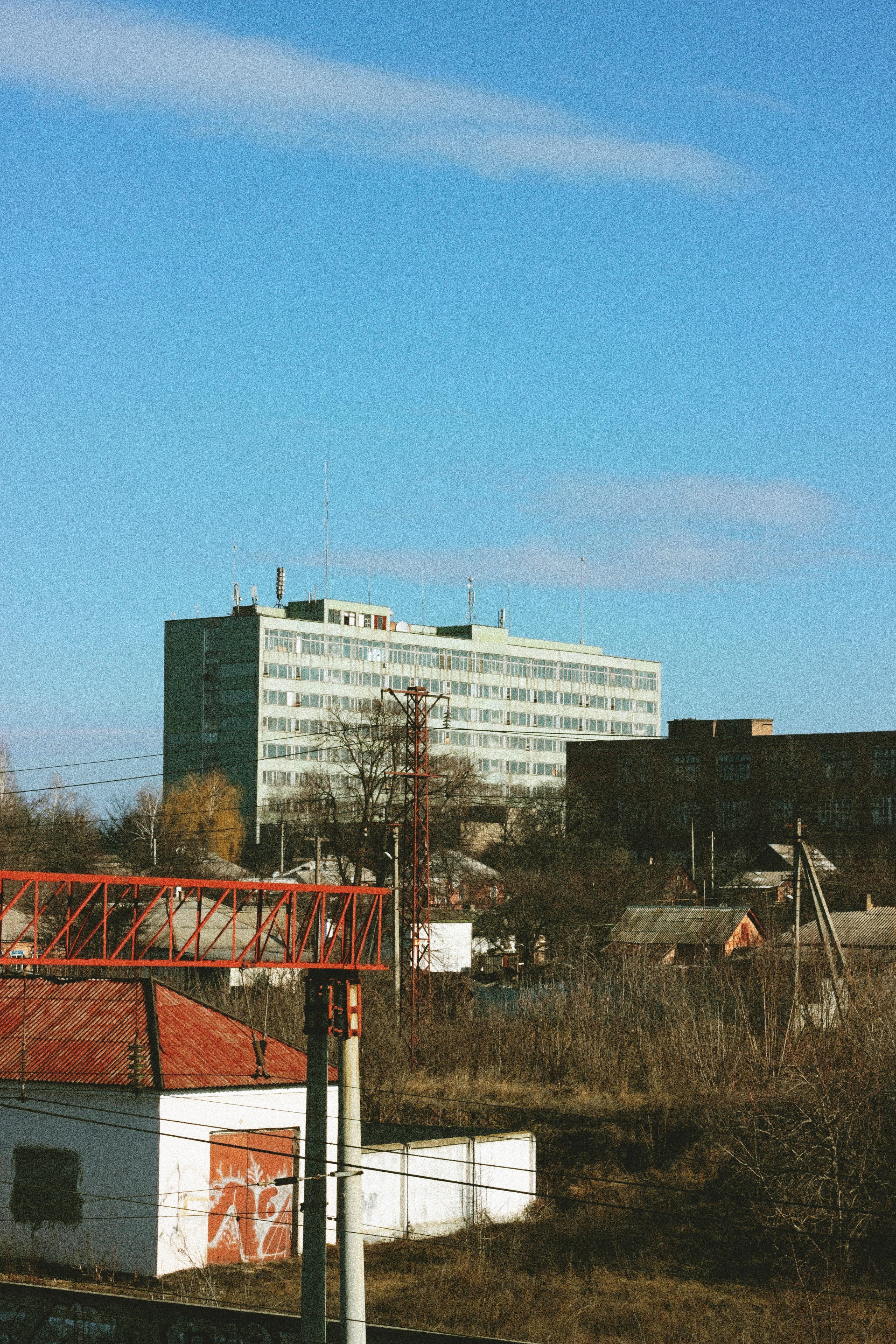 white concrete building near green trees during daytime