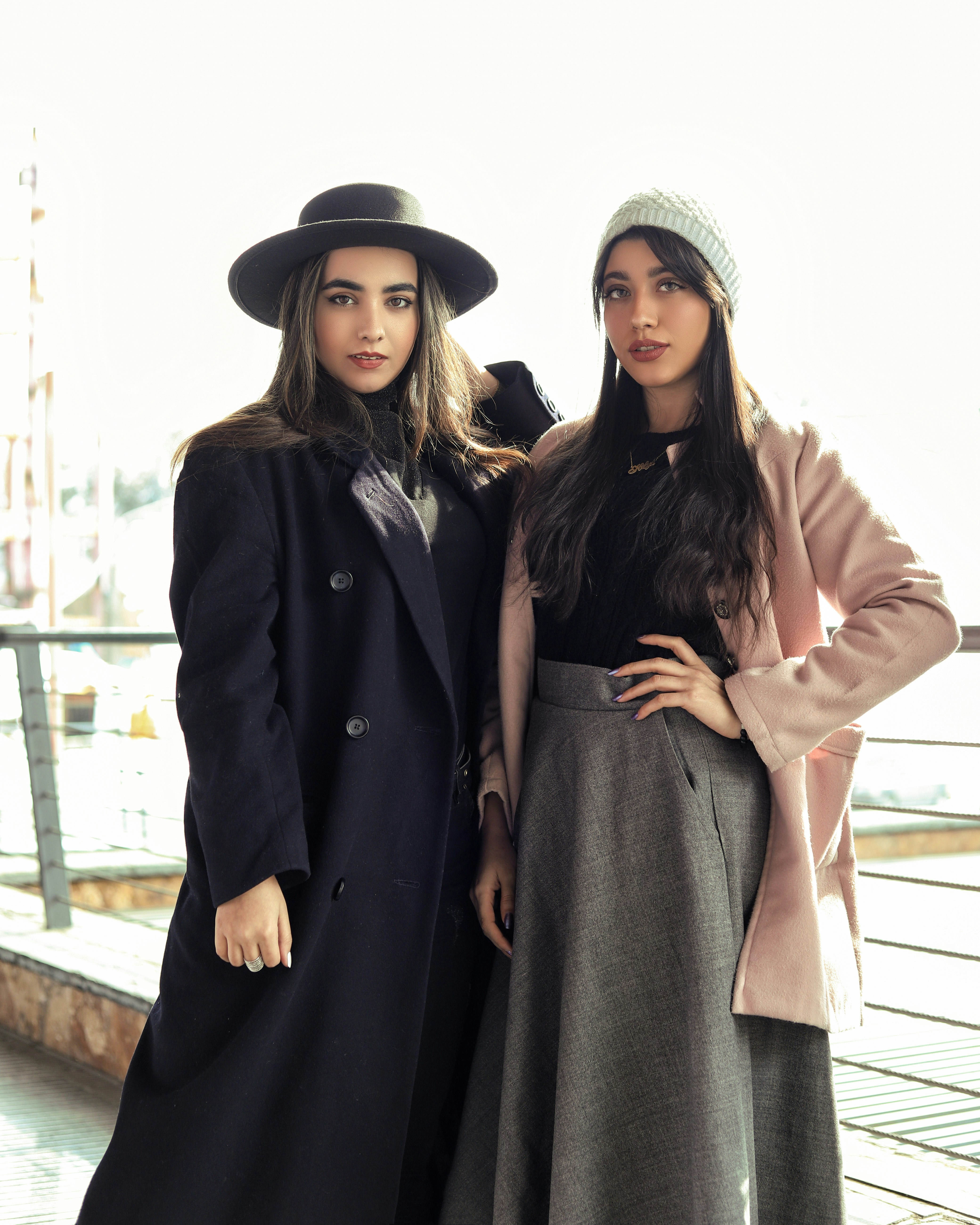 Two Fashion-forward Women on a Sunlit Balcony