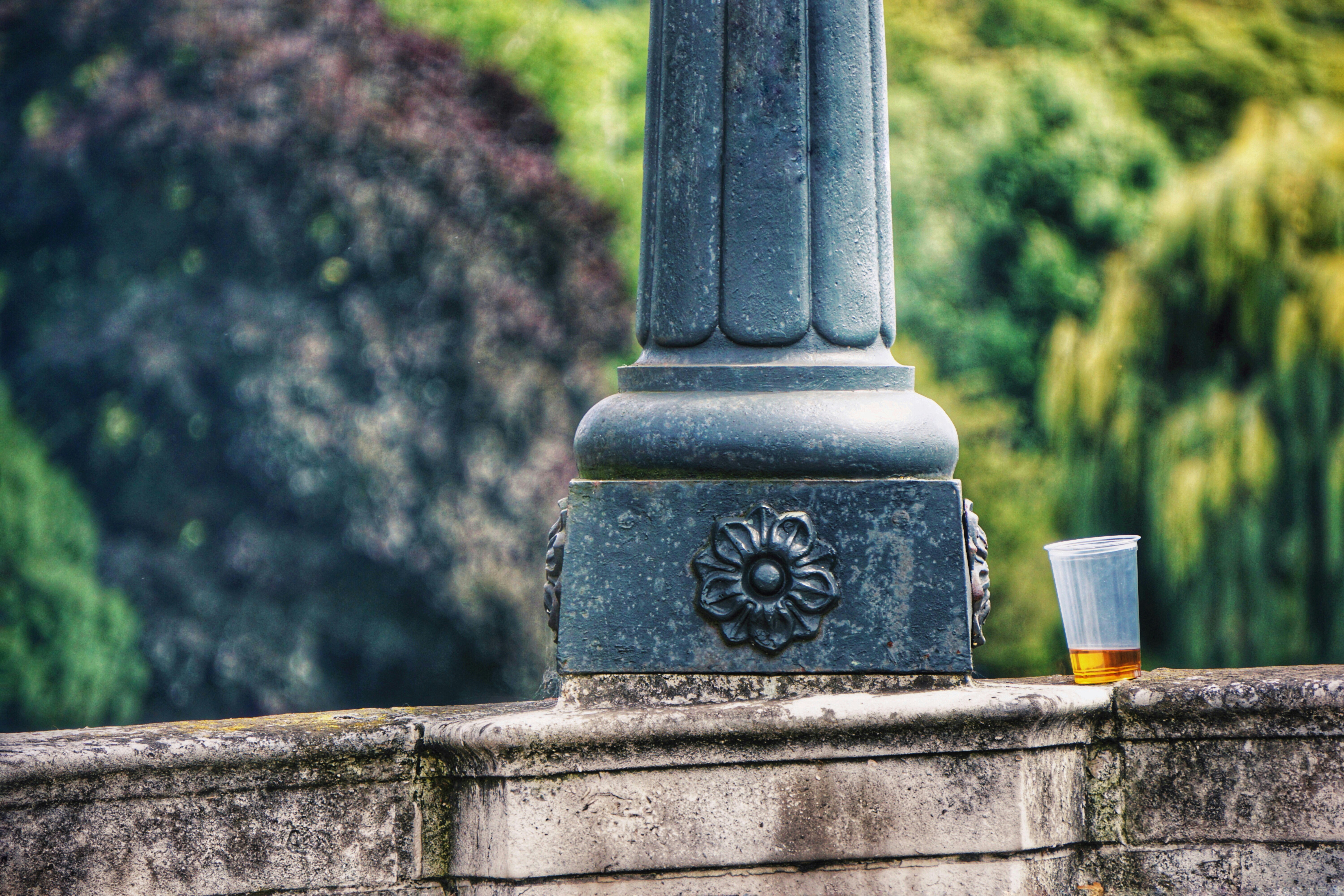 Amber Glass by the Lantern: Quiet Moment on a Mossy Veranda