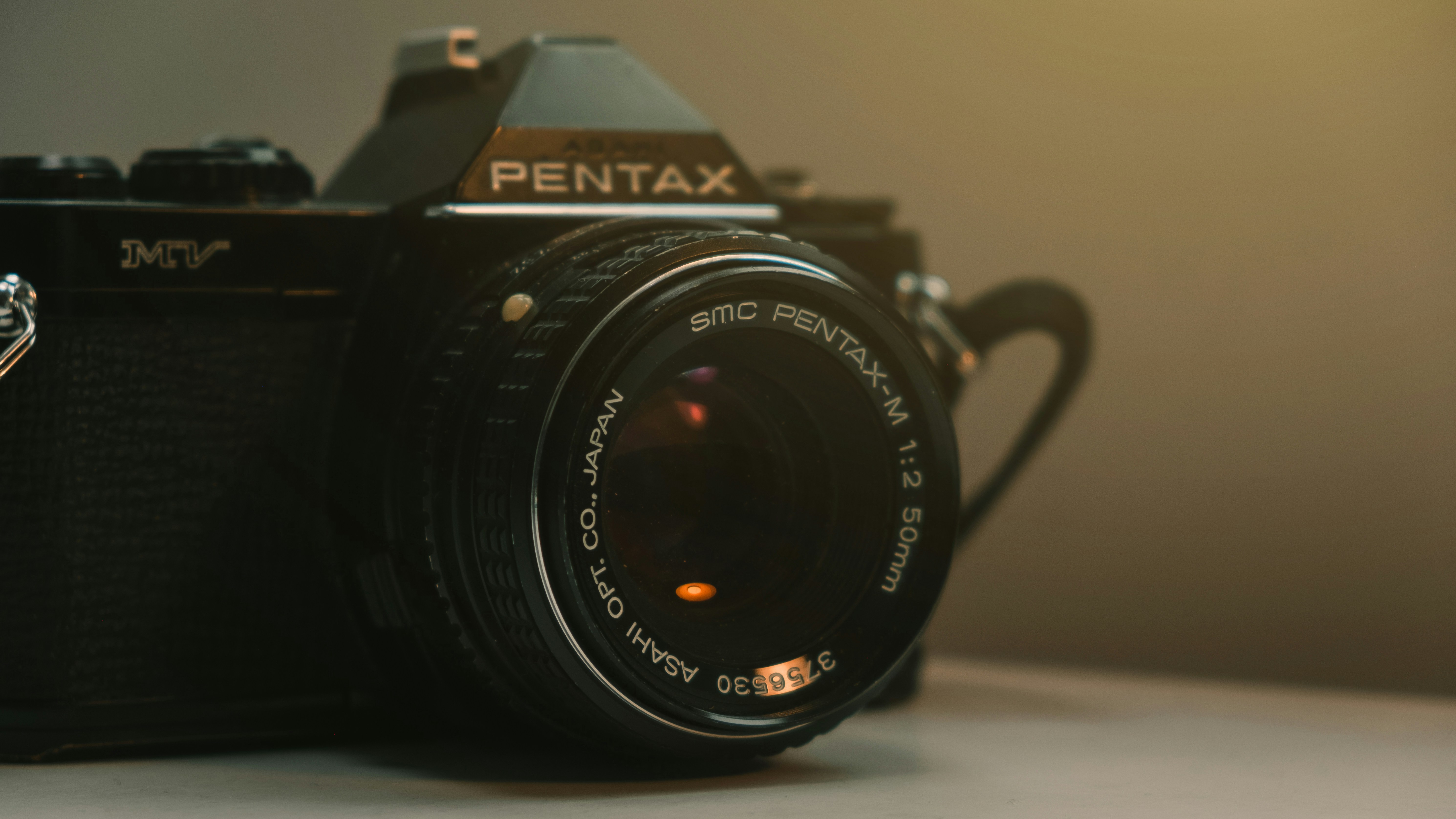 Warm Grit: close-up of a vintage Pentax film camera with a 50mm lens
