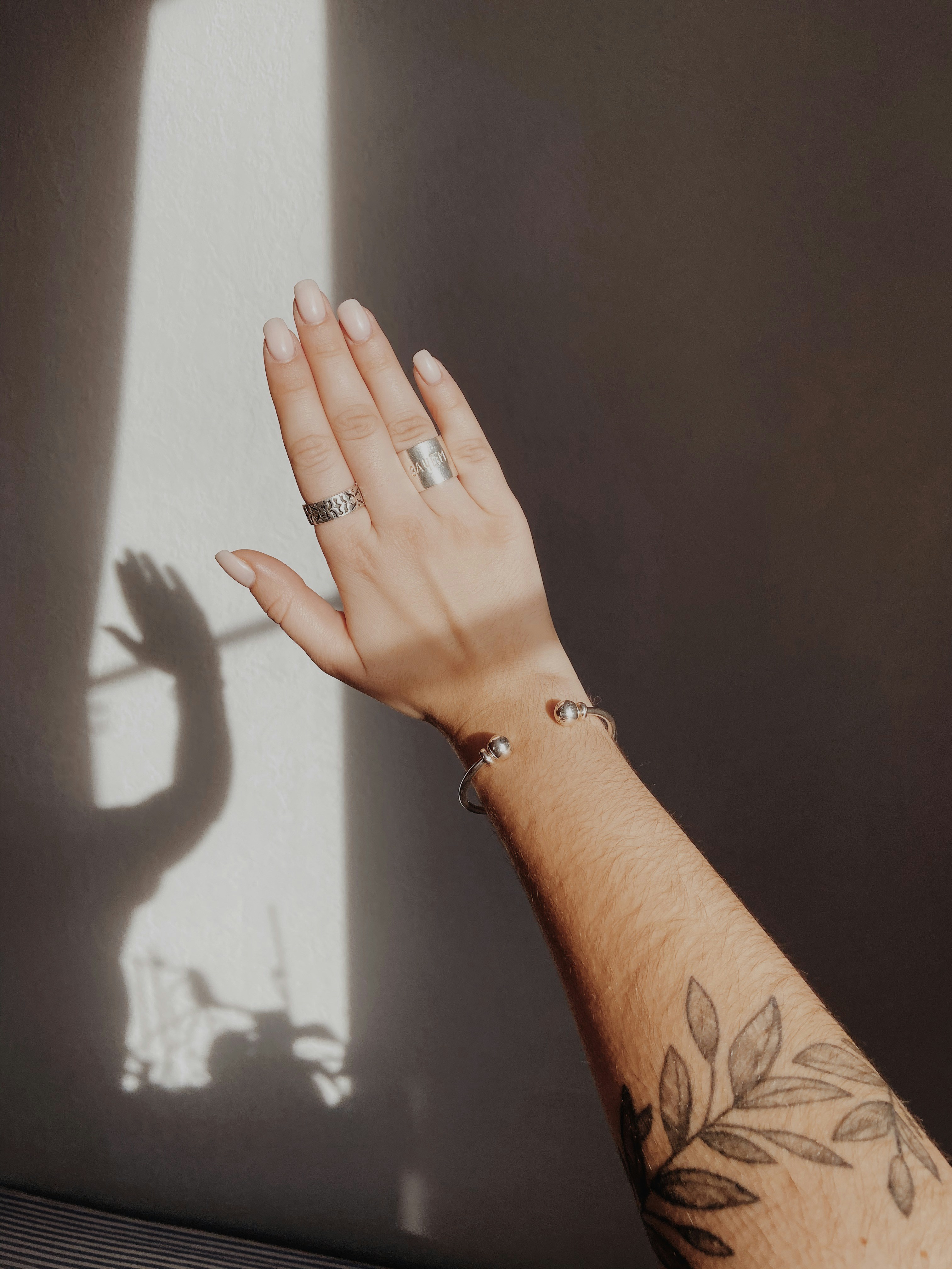 Sunlit Hand, Shadowed Wall: A Quiet Study in Jewelry and Ink