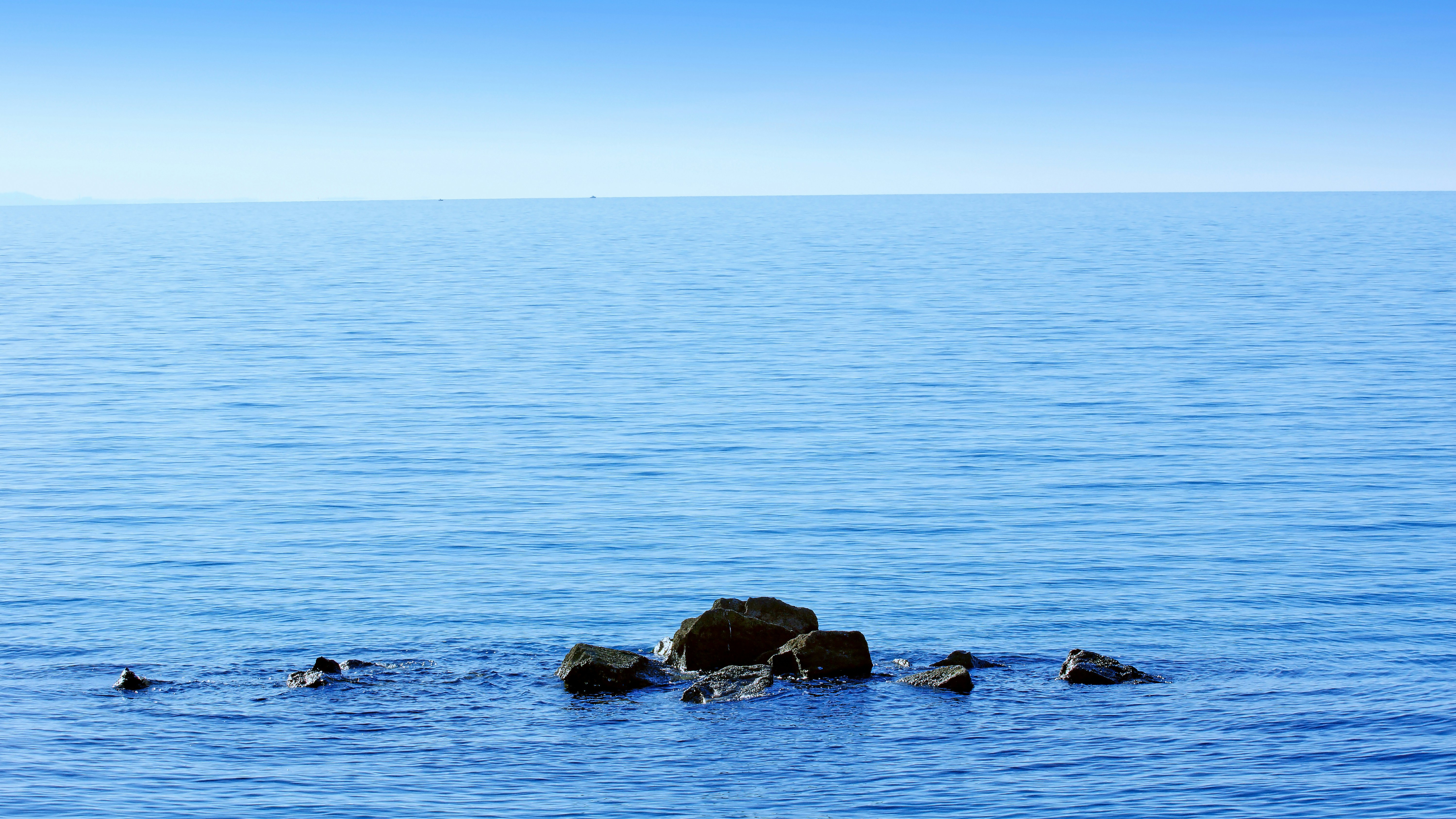 Stone Outcrops Stand Guard Over a Calm Blue Sea