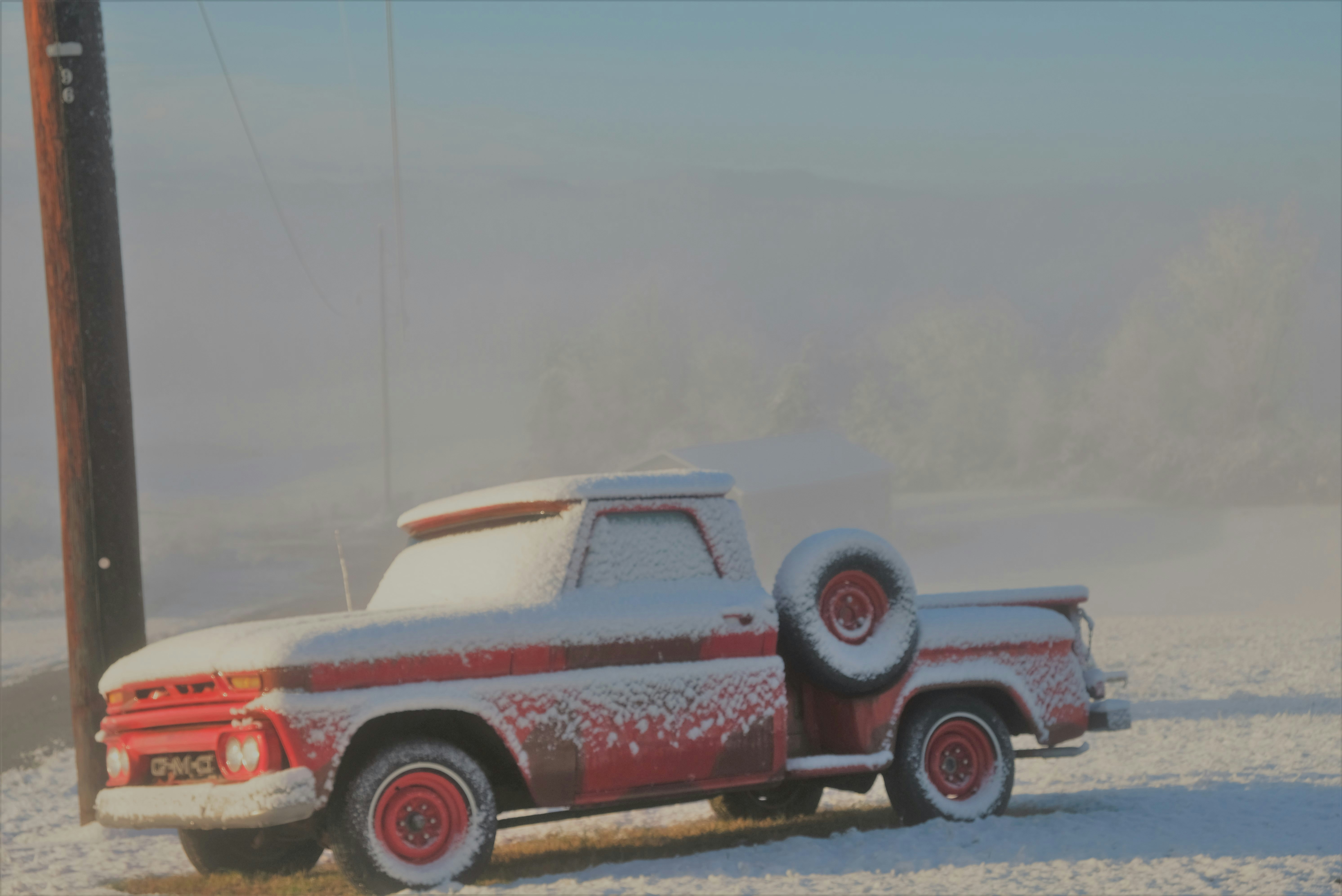 White and red chevrolet single cab pickup truck on snow covered ground ...