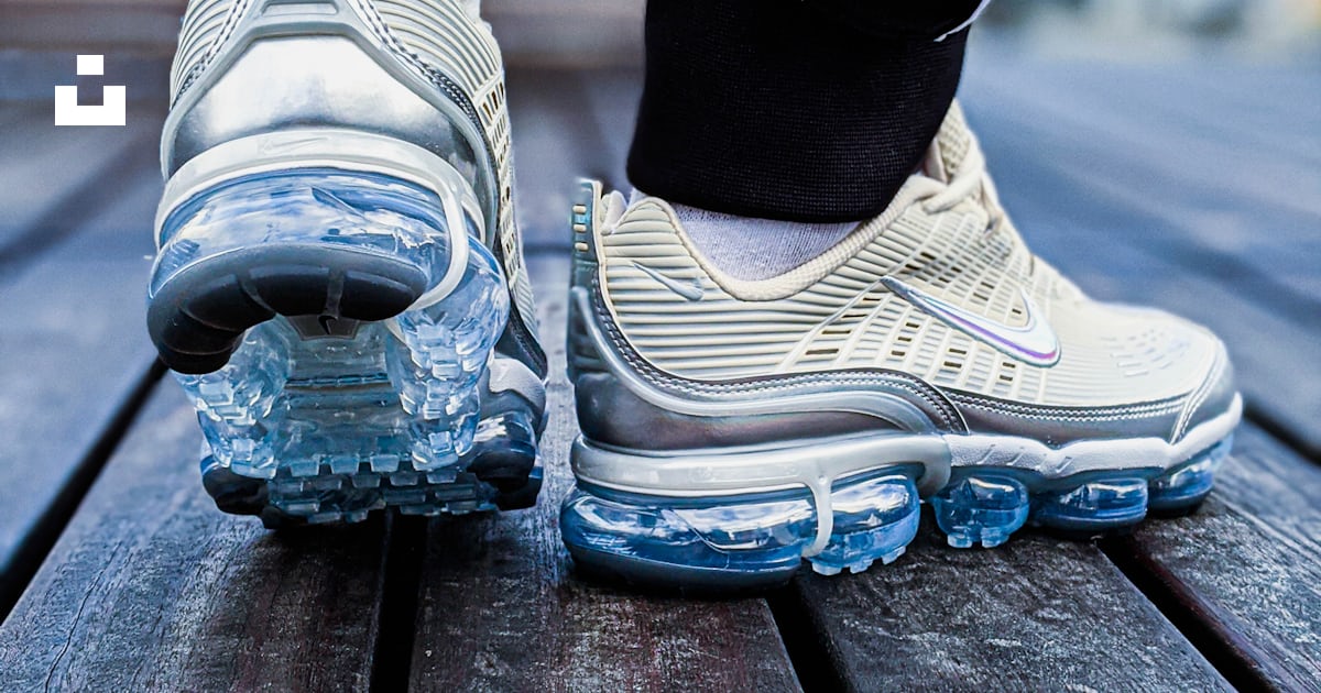 Person Wearing Gray And White Nike Athletic Shoes Photo Free