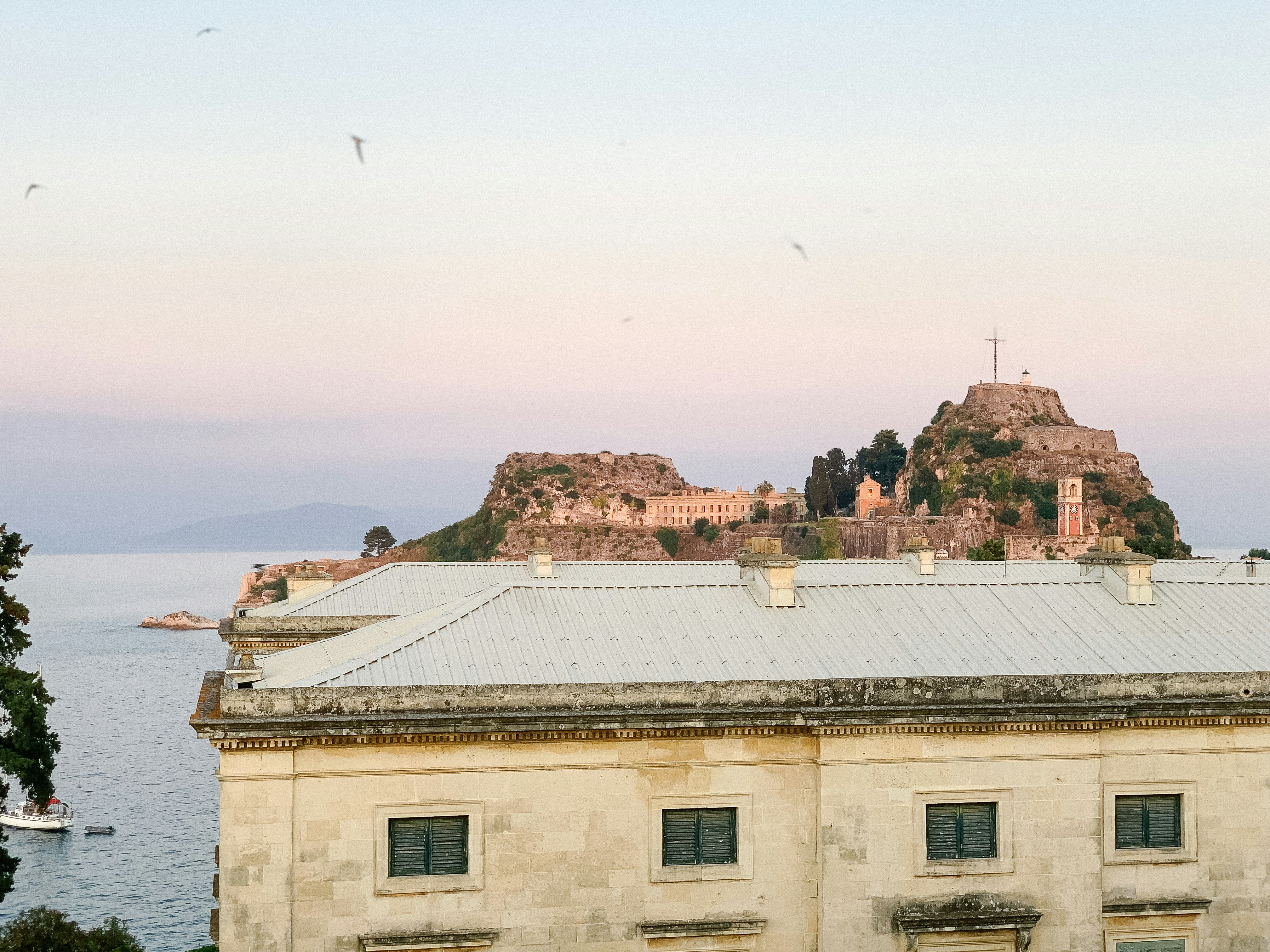 White concrete building near body of water during daytime photo – Free ...