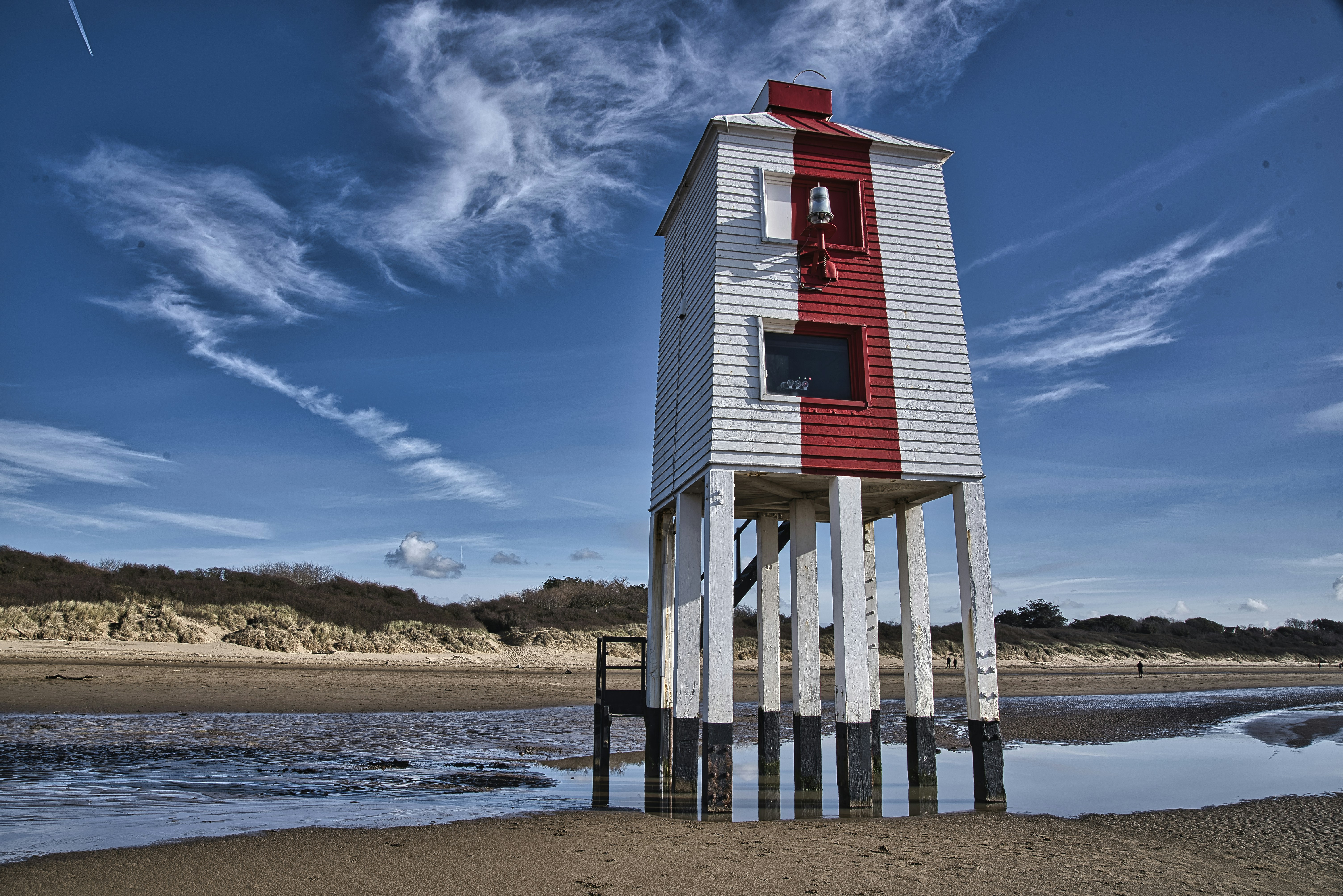 White and red wooden lifeguard house on beach shore during daytime ...