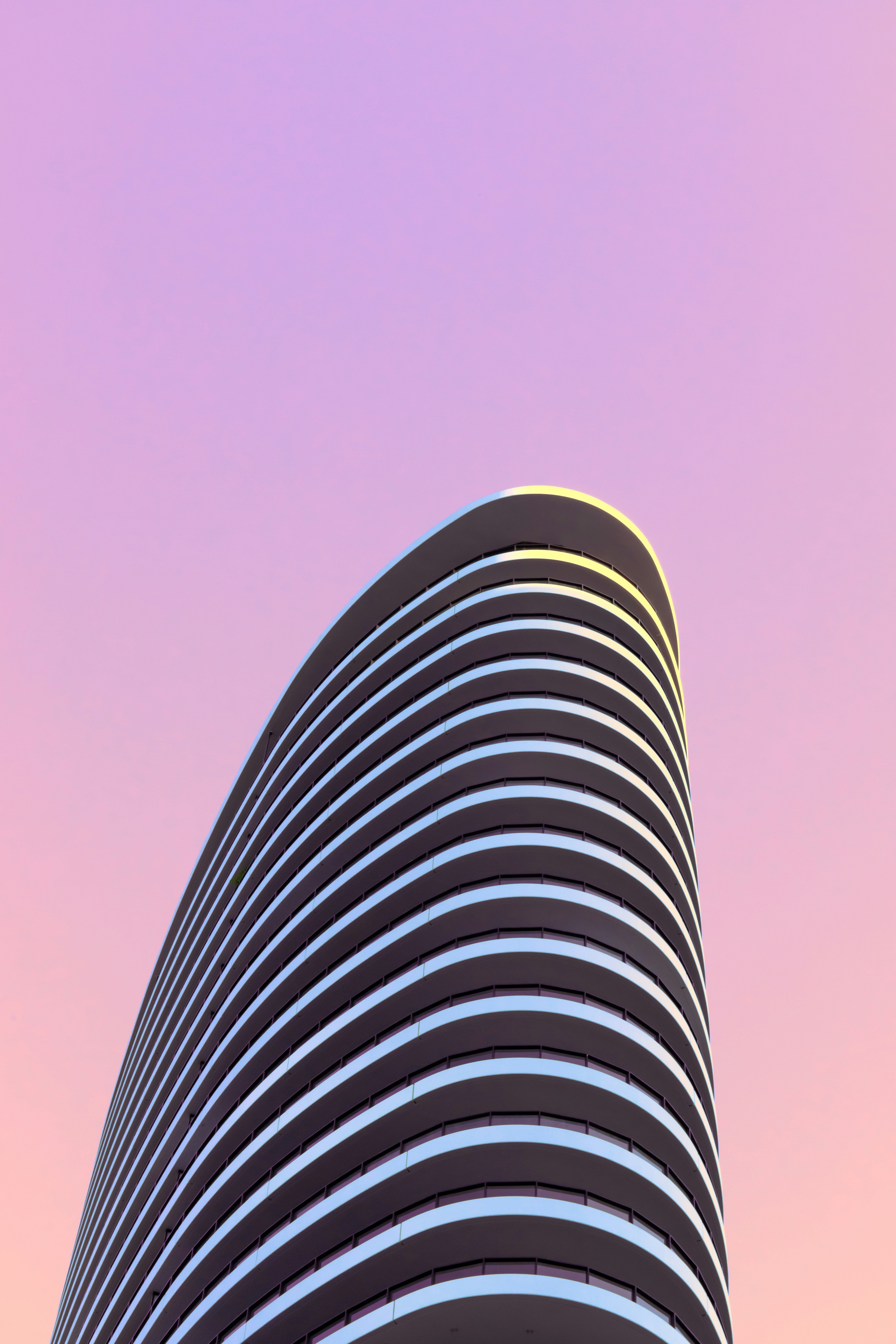 Sunset Spiral: A Ribbed Tower Reaches into a Pink Sky