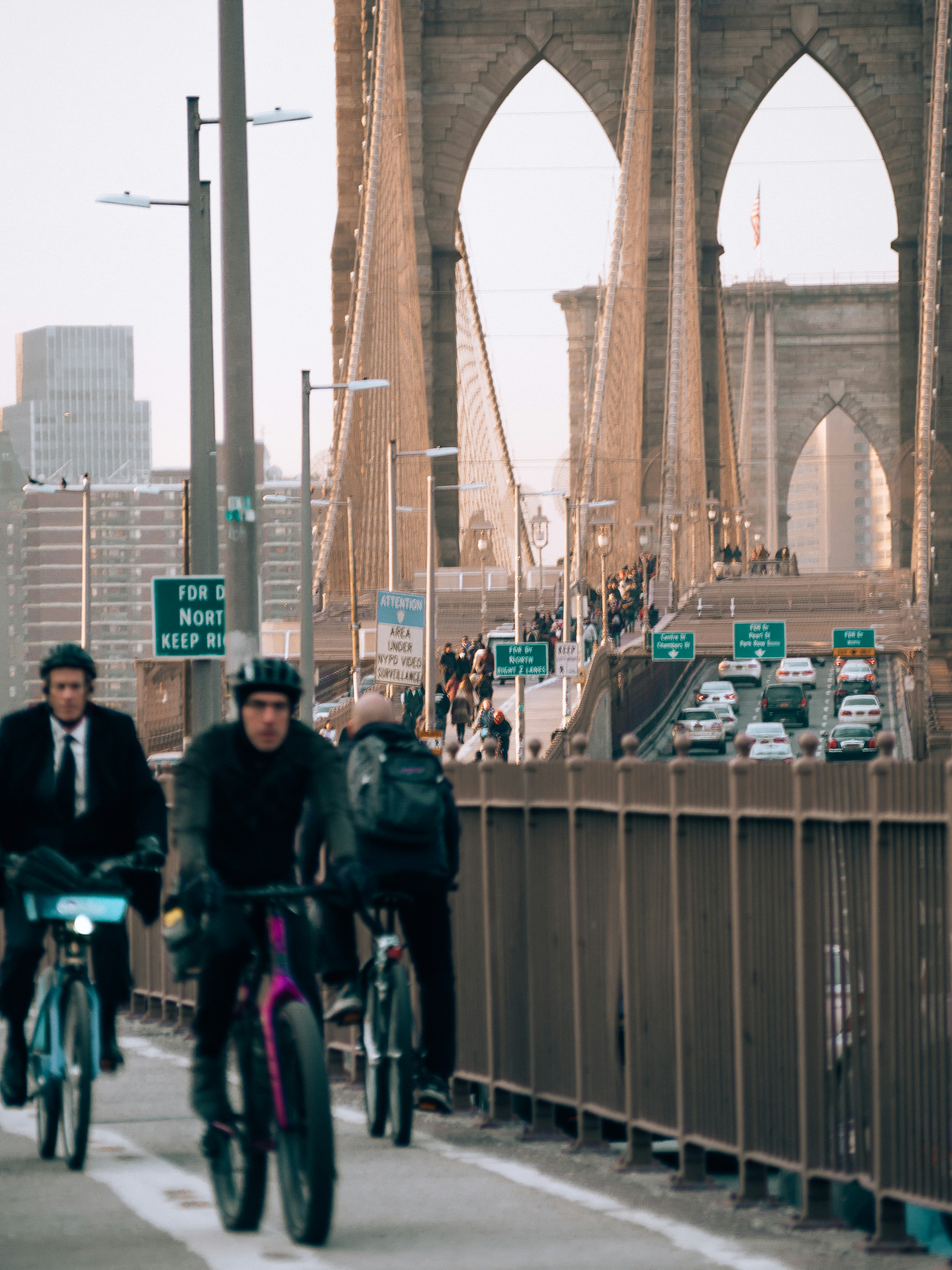 people riding bicycles on road during daytime