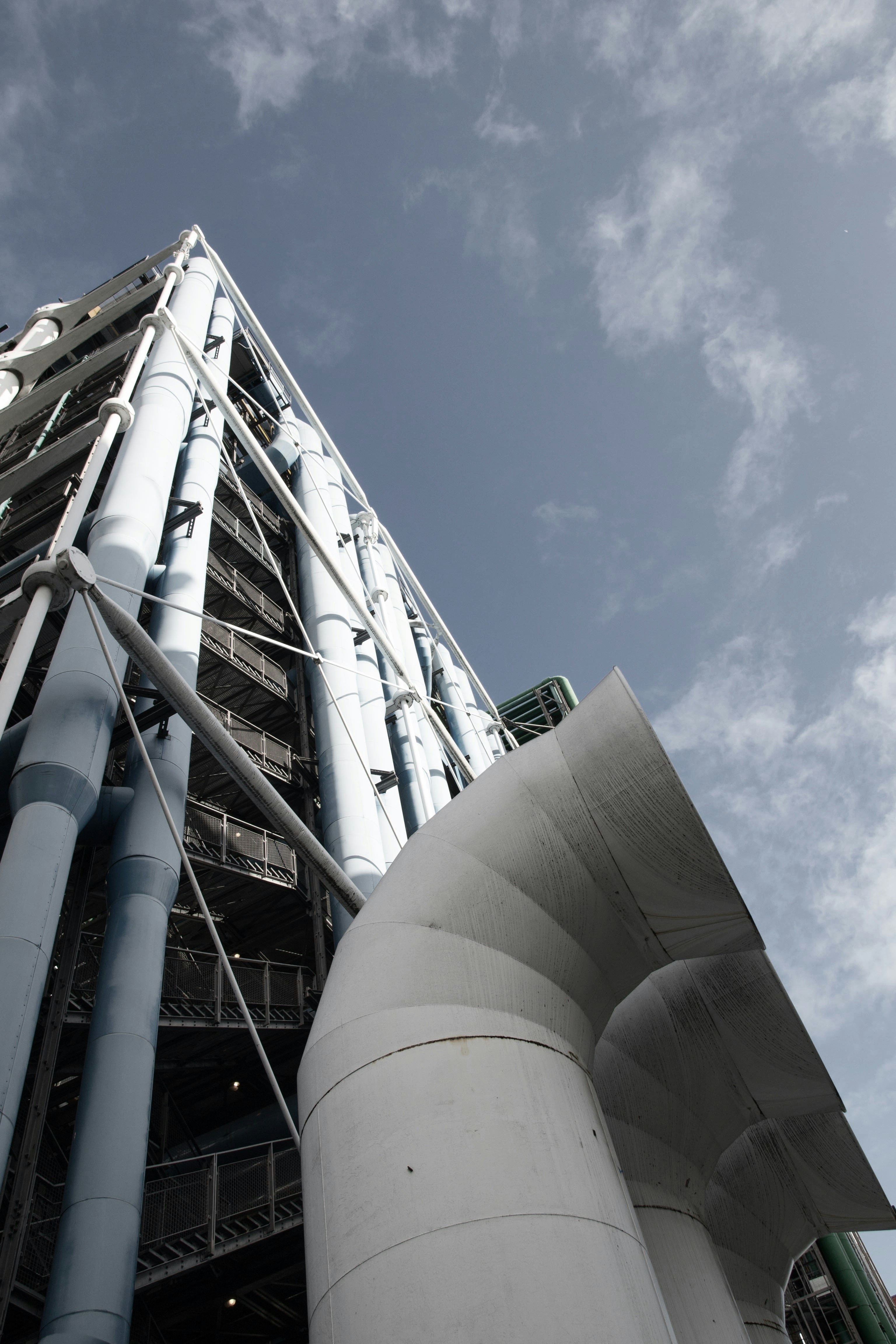Architectural ascent: angled steel spires piercing a blue sky