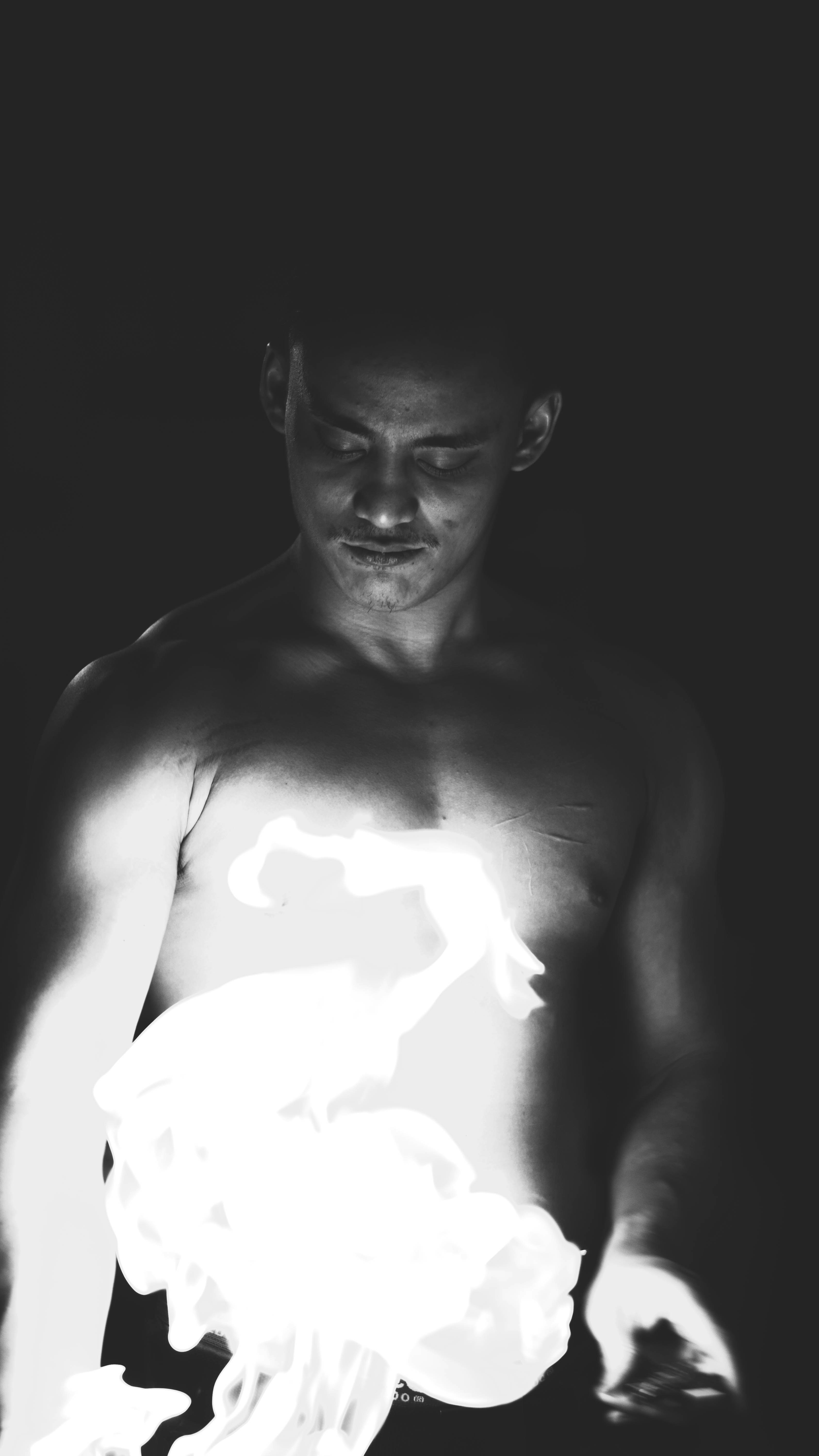 Low-Key Portrait: Illuminated Torso in Smoke and Shadow
