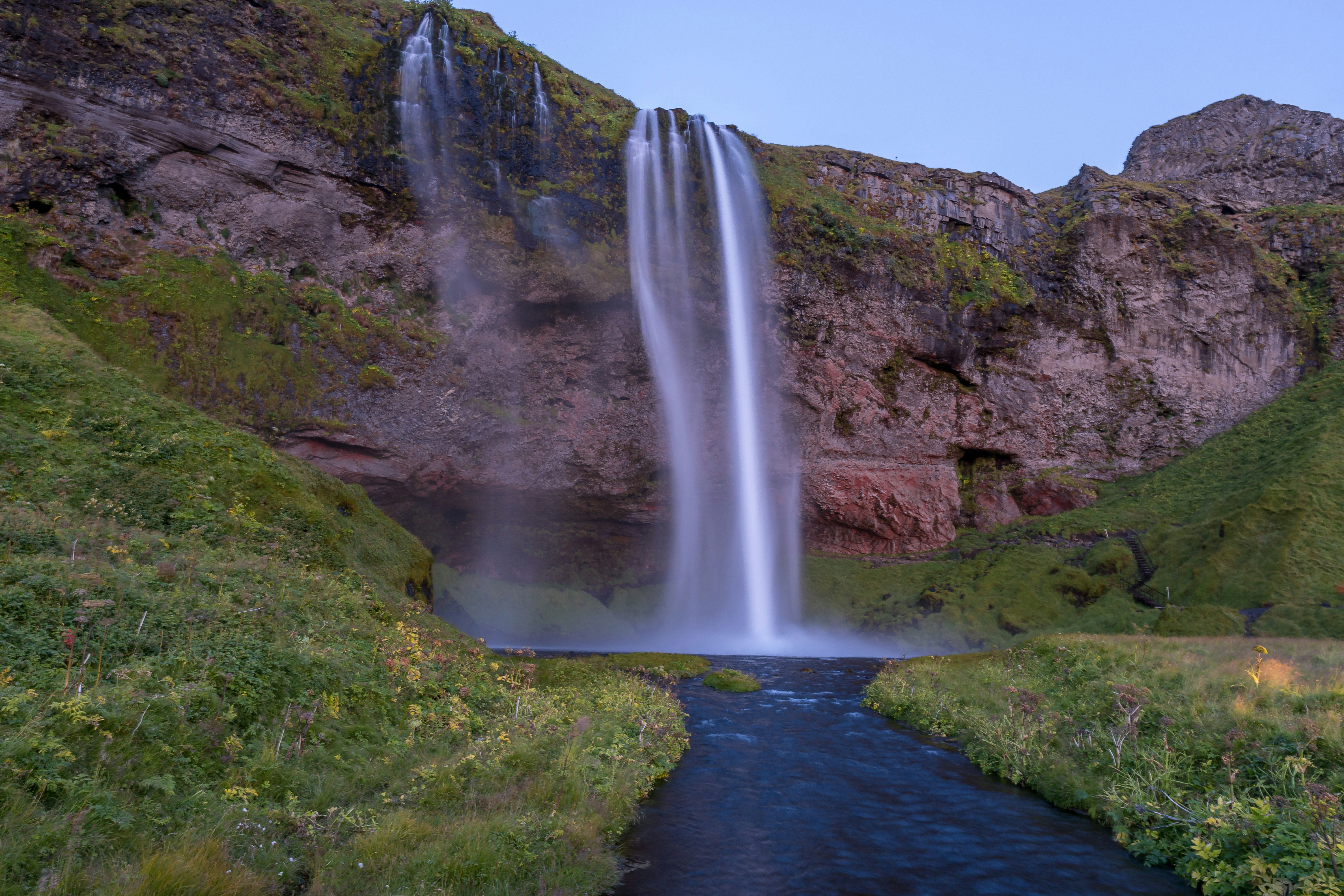 Verdant Gorge Falls: A Vertical Curtain Over a Narrow Icelandic Ravine