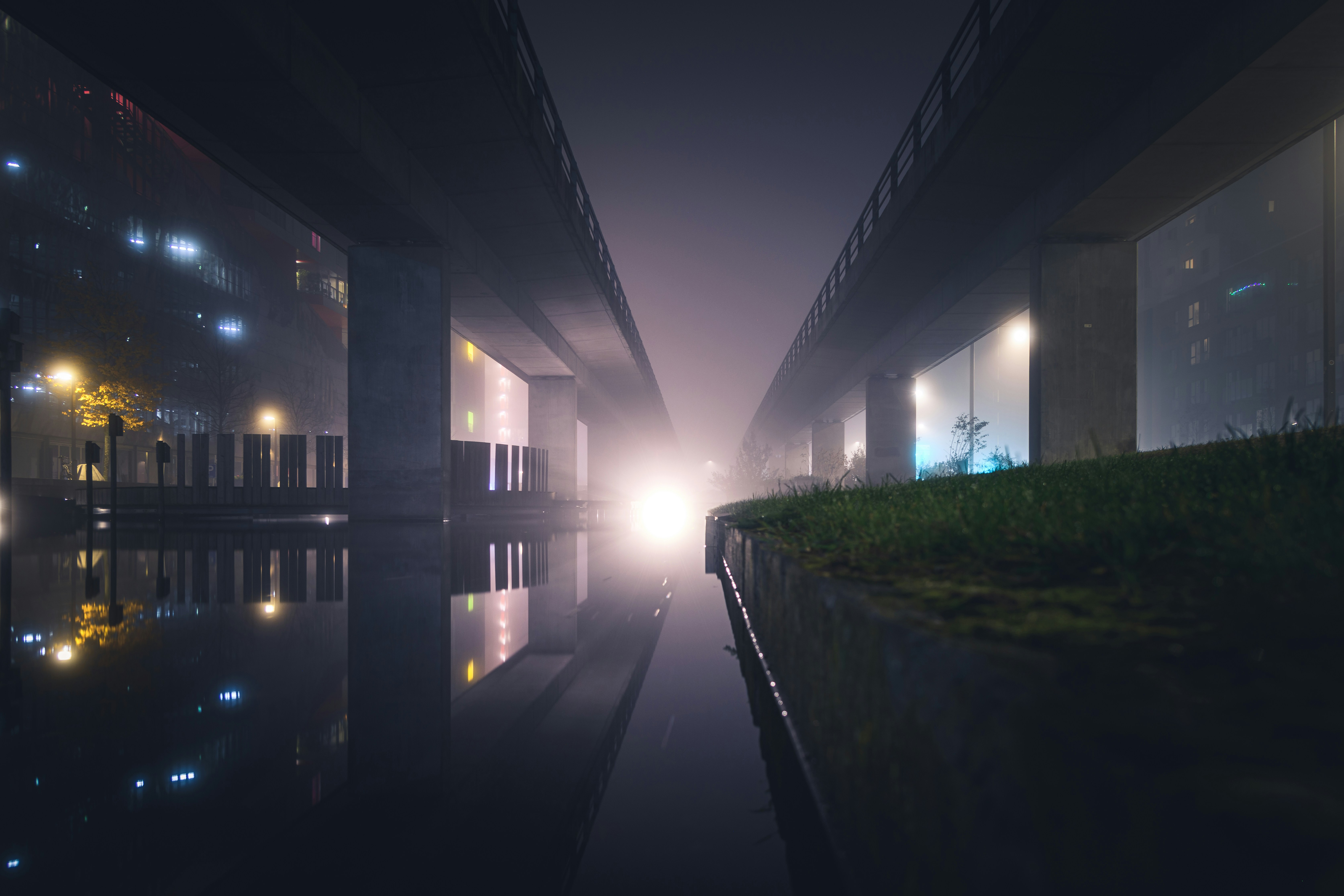 Gray concrete bridge over river during night time photo – Free ...
