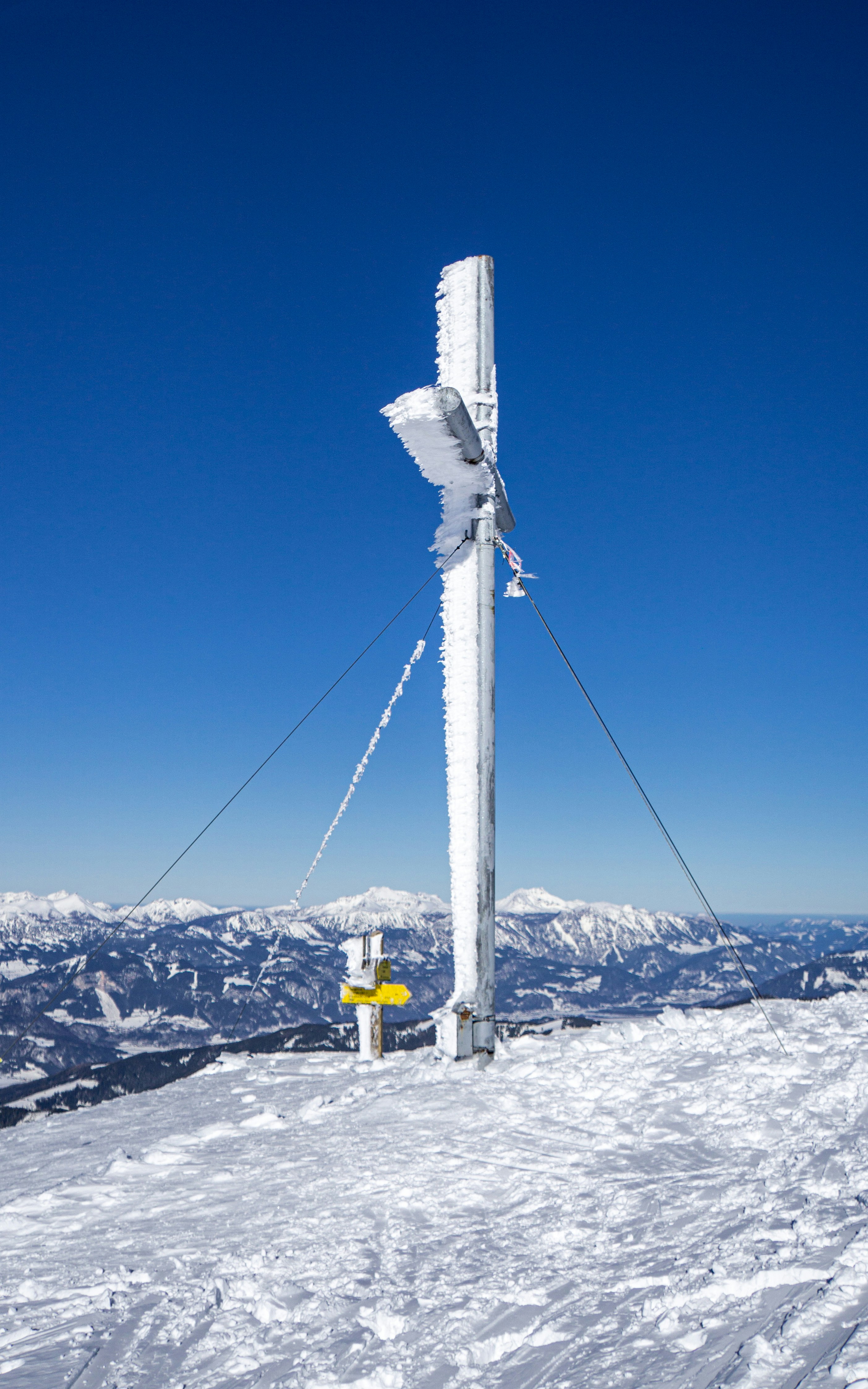Cerulean Sky Over a Snowbound Summit Cross