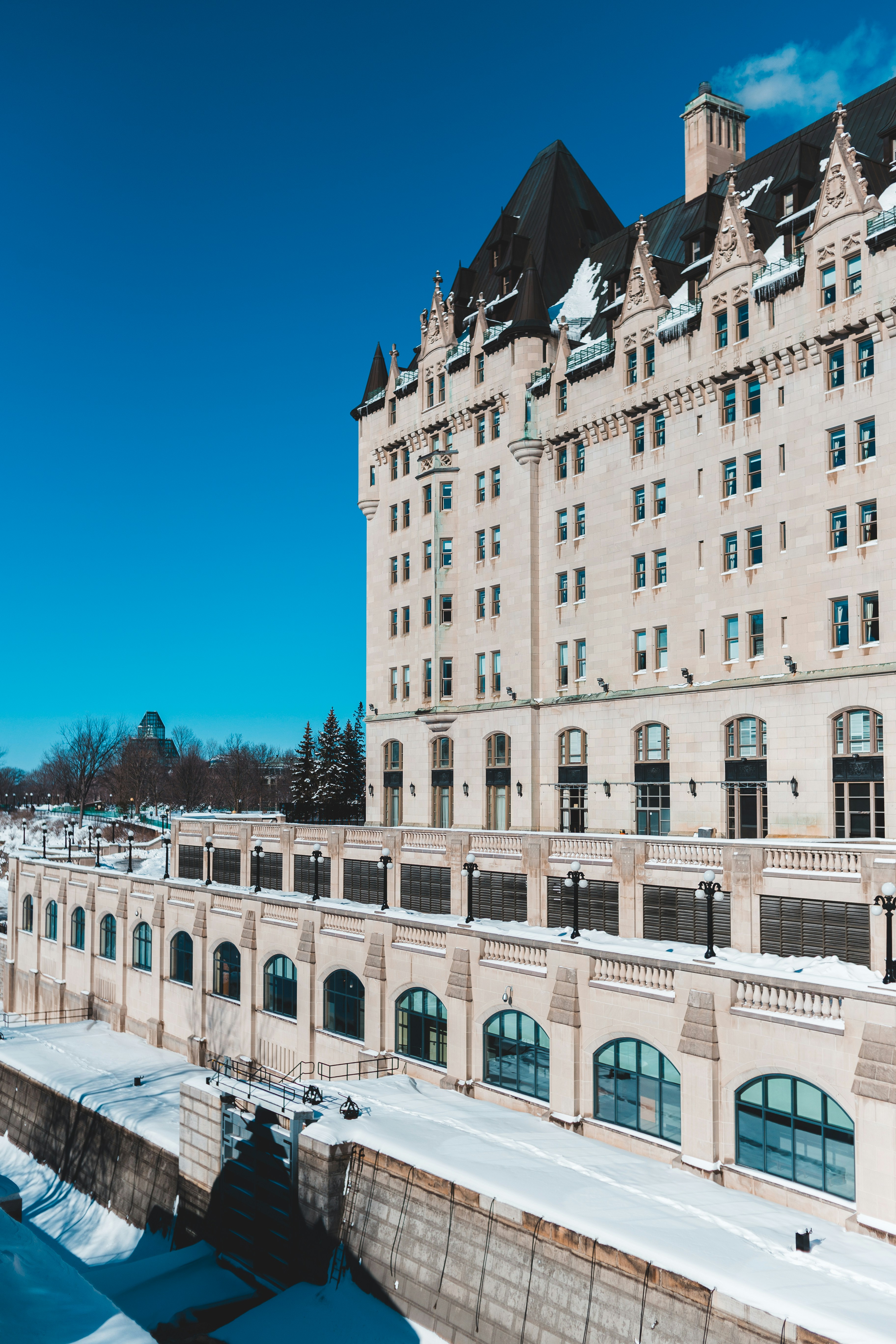 Chateau by the Canal: Snow-Quiet Facade Under a Blue Winter Sky