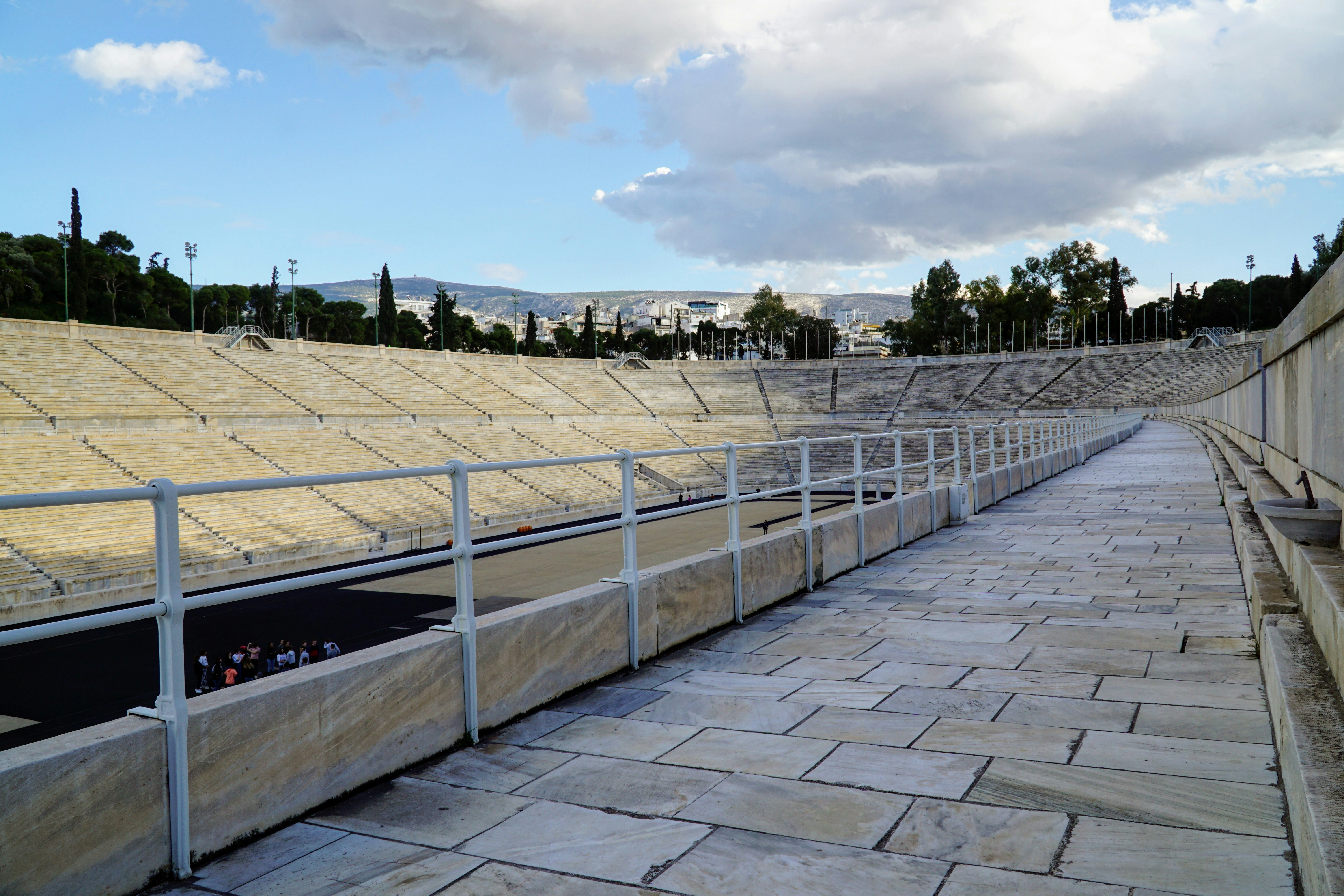 The Panathenaic Stadium in Athens, showcasing its grand marble structure and empty seating, invites reflection on history and sport.