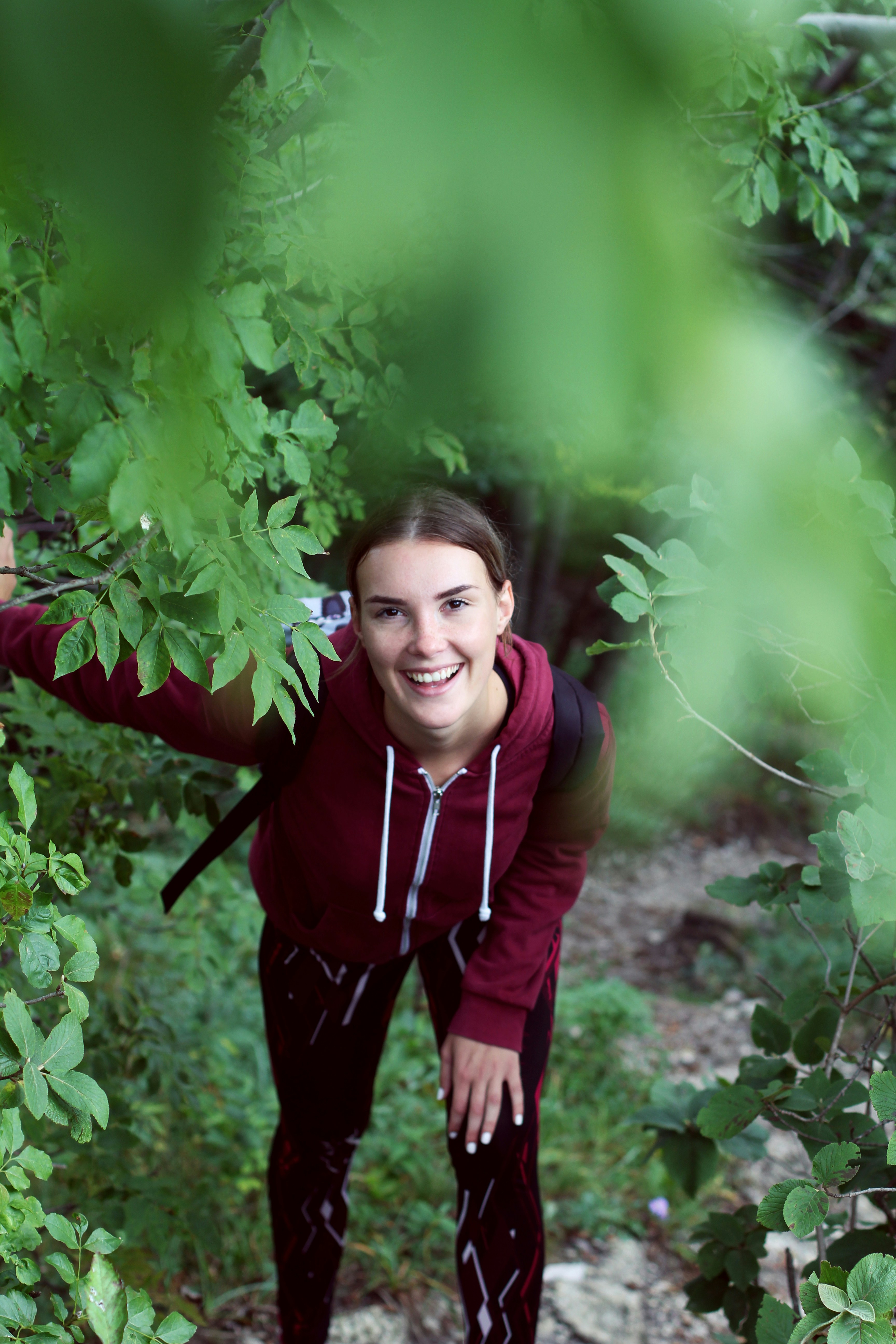 Smiling Explorer Peeking Through a Green Curtain