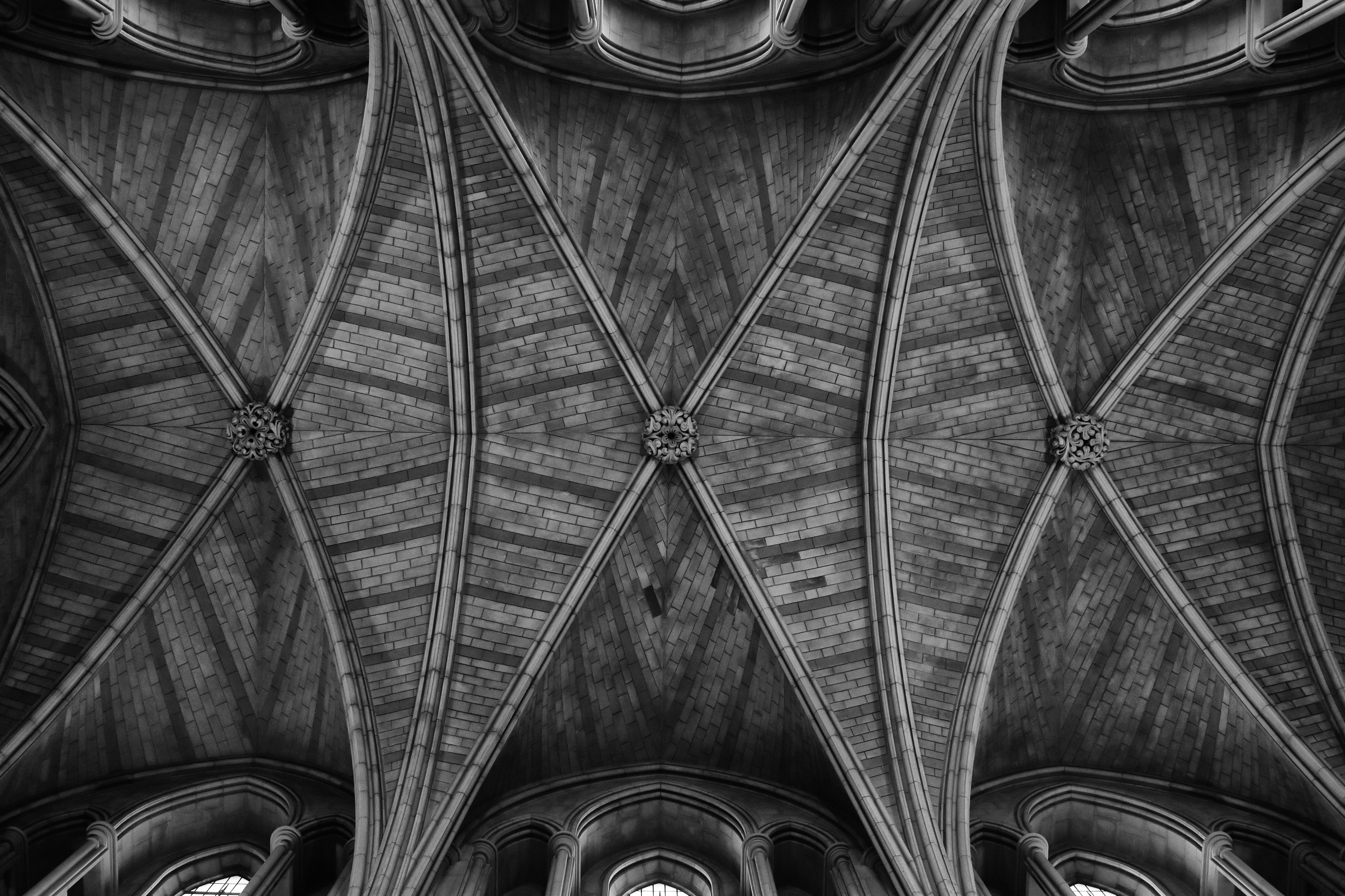Intricate gothic ceiling with intersecting arches and decorative stone elements.