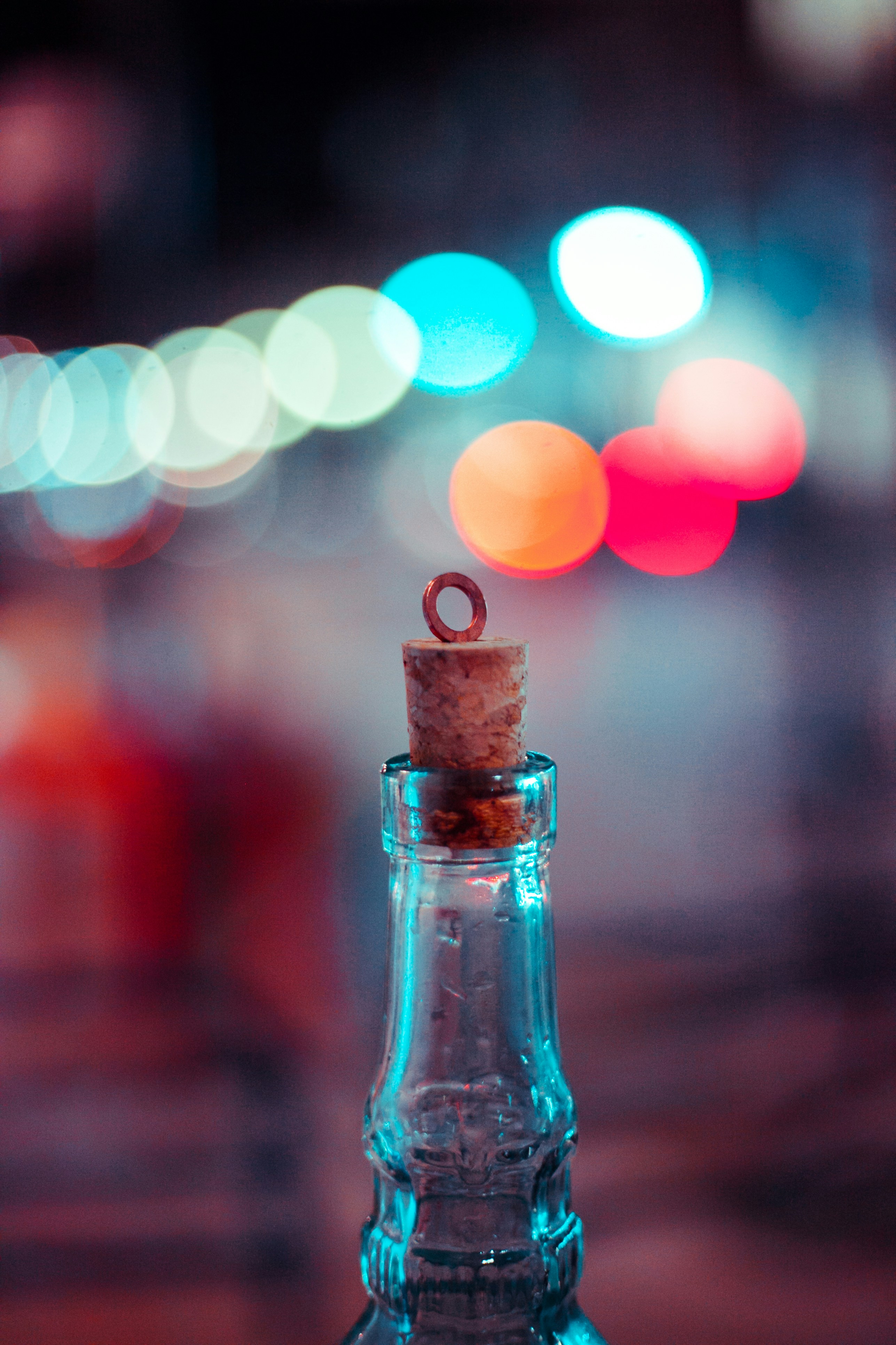 Bokeh Bottle: A Close-Up of a Corked Glass Gem Under Neon Night