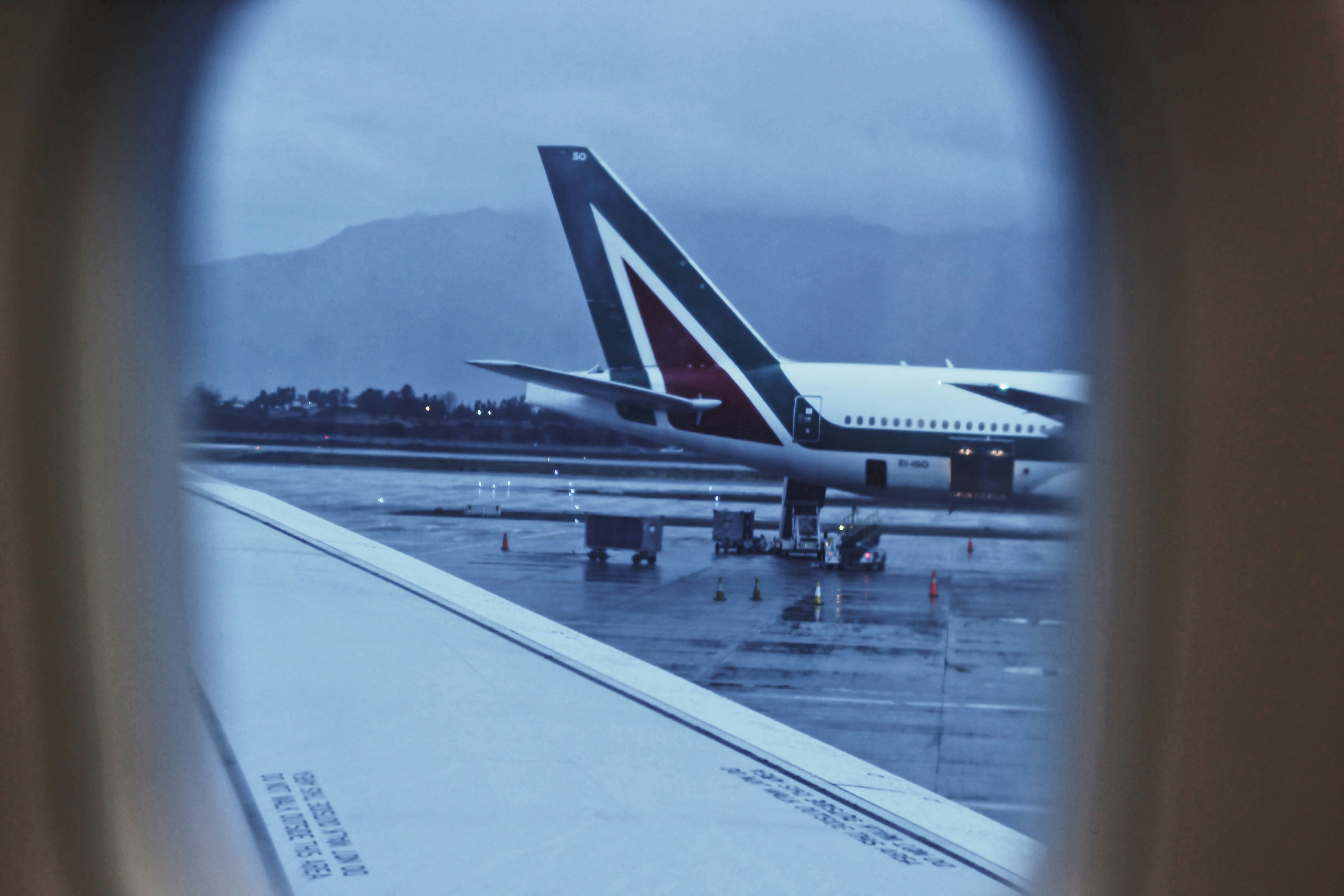 White airplane wing over the city during daytime photo – Free Blue ...