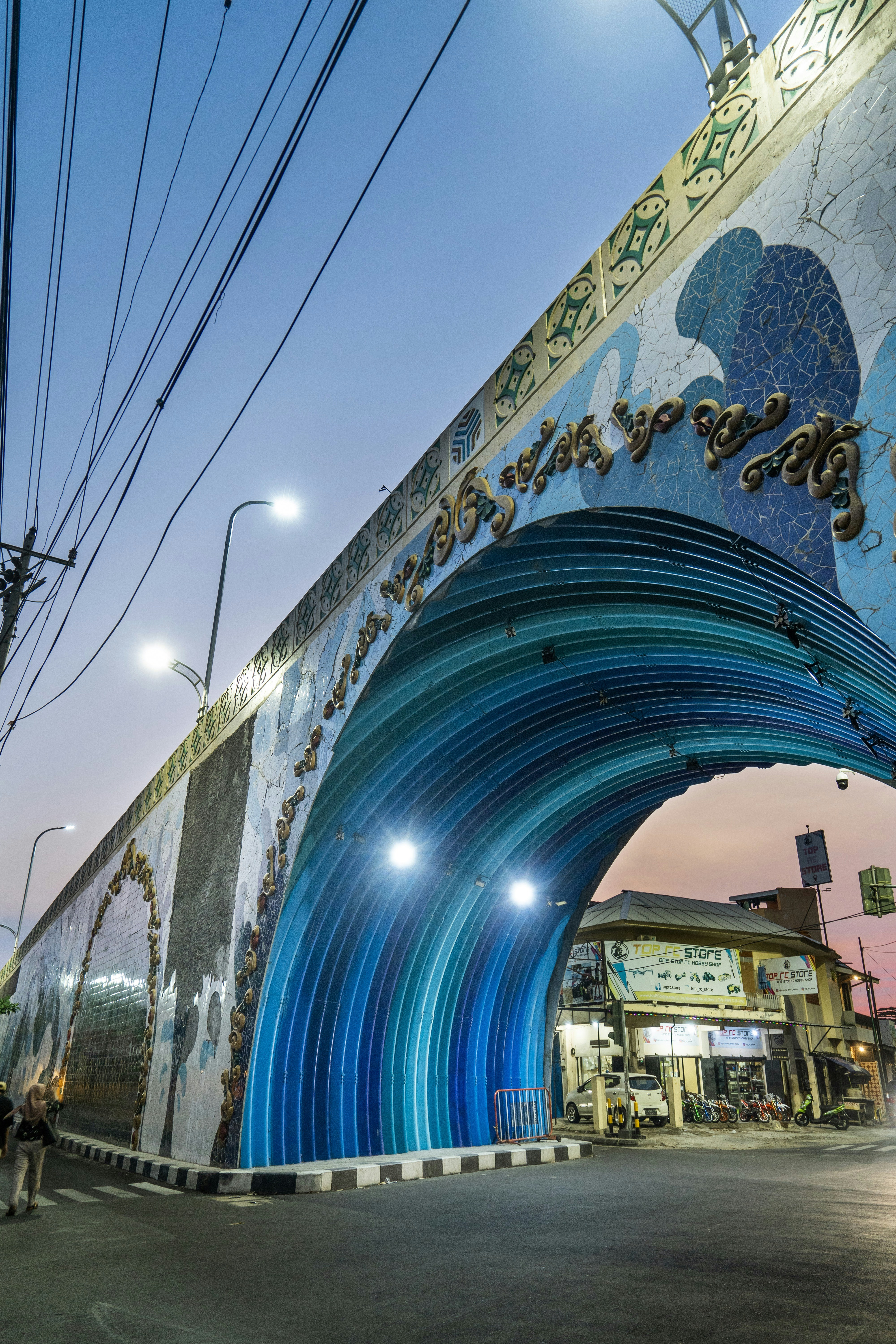 Blue Archway Underpass: A Neon Corridor into Evening Streetlife