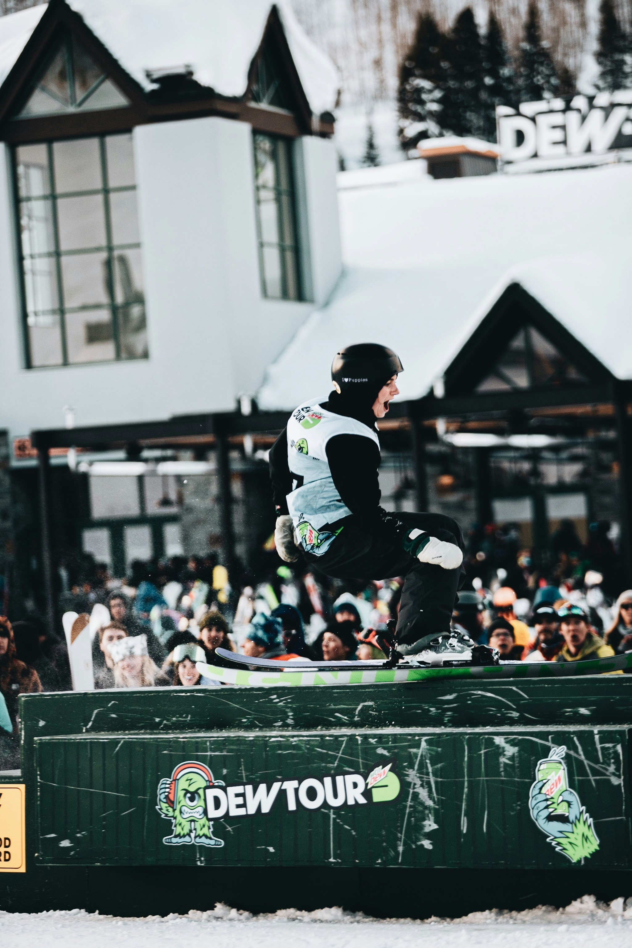 man in black and white long sleeve shirt and black pants jumping on green skateboard during