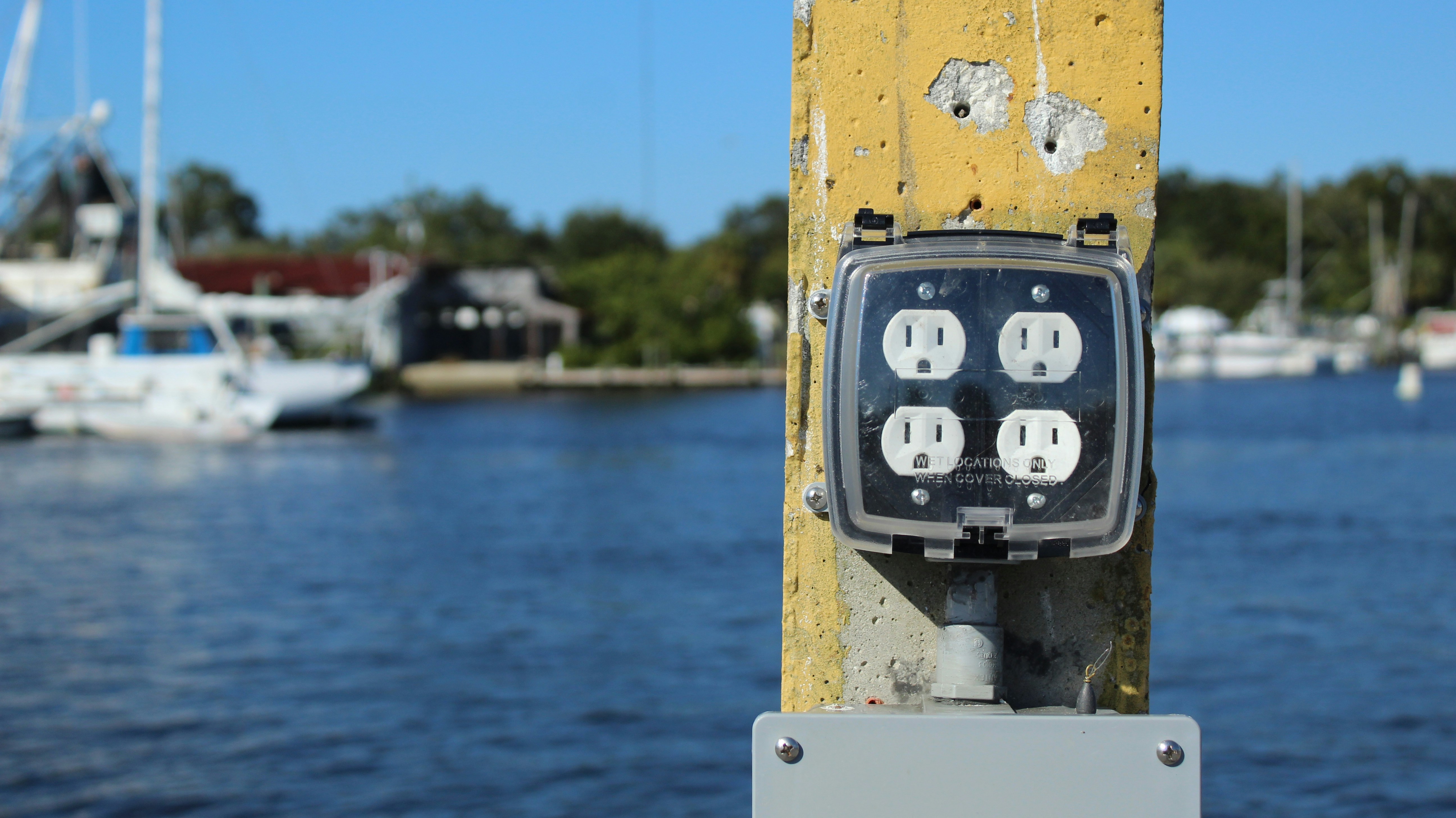 Weathered Dock Socket Framing a Quiet Marina