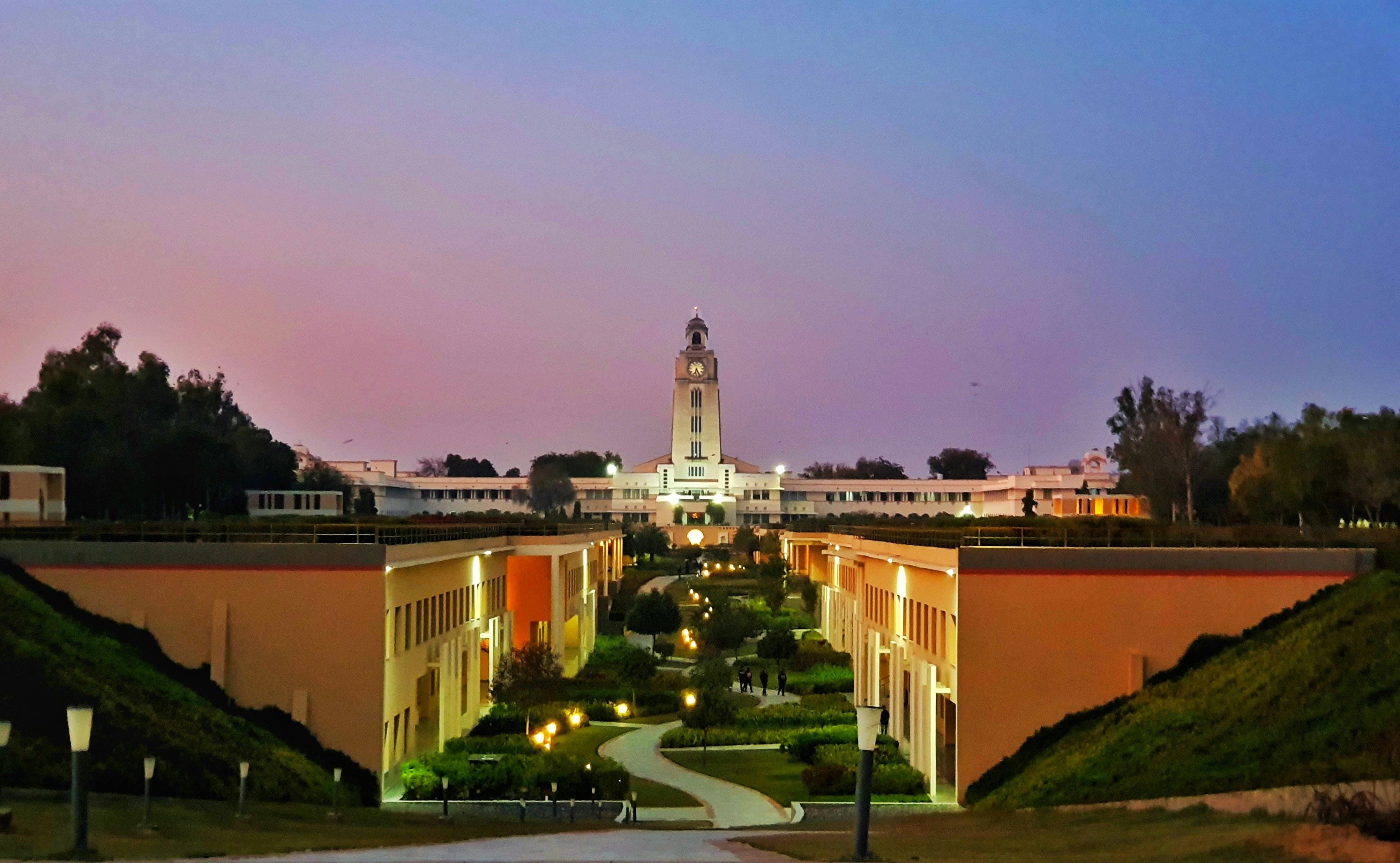 Dusk Clocktower: Symmetry Over a Lantern-lit Campus Quad