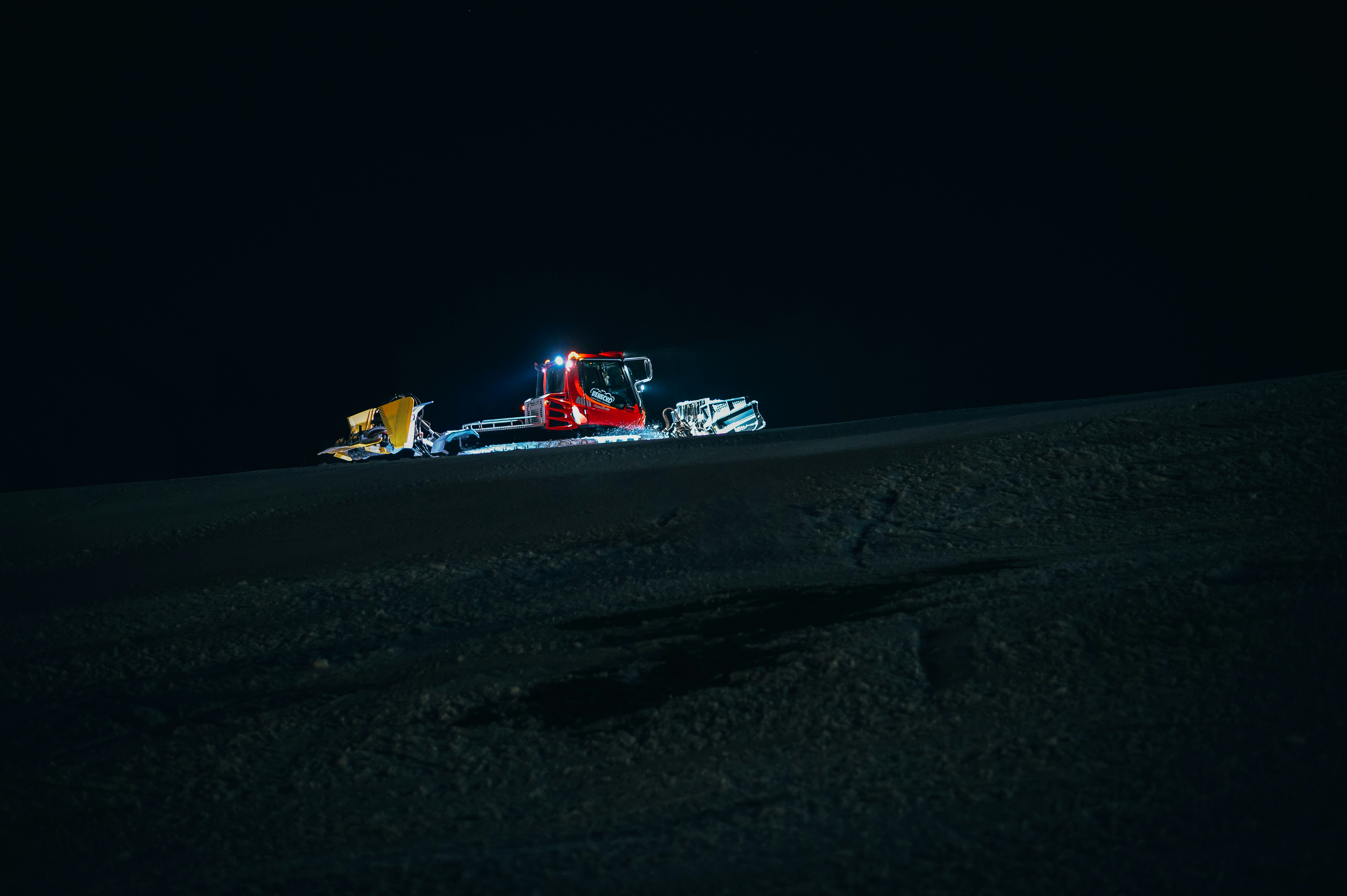 Red and white formula 1 on snow covered ground during night time photo ...