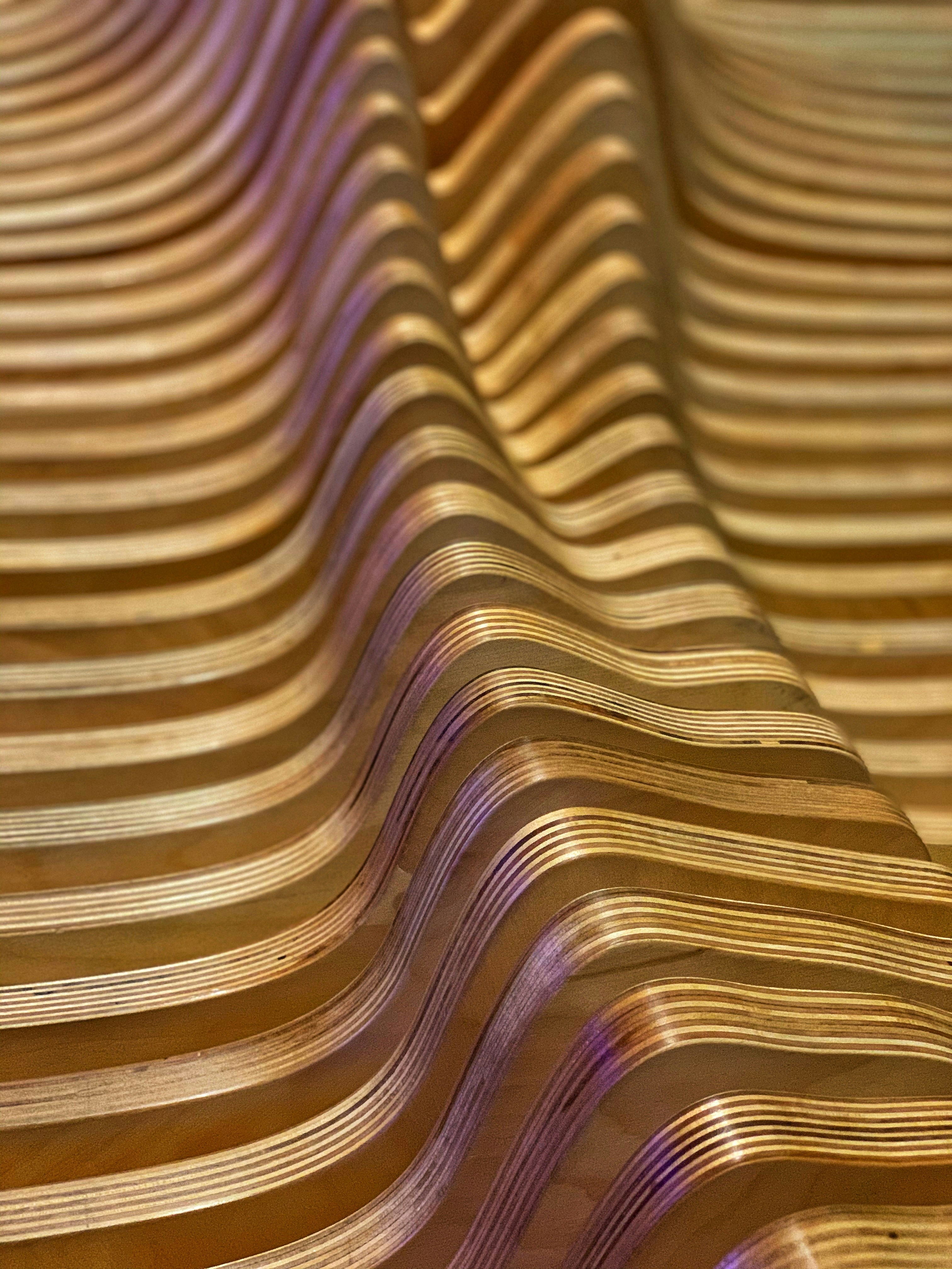 Gold-Toned Ridges: A Macro Portrait of Wavy Metal Pleats