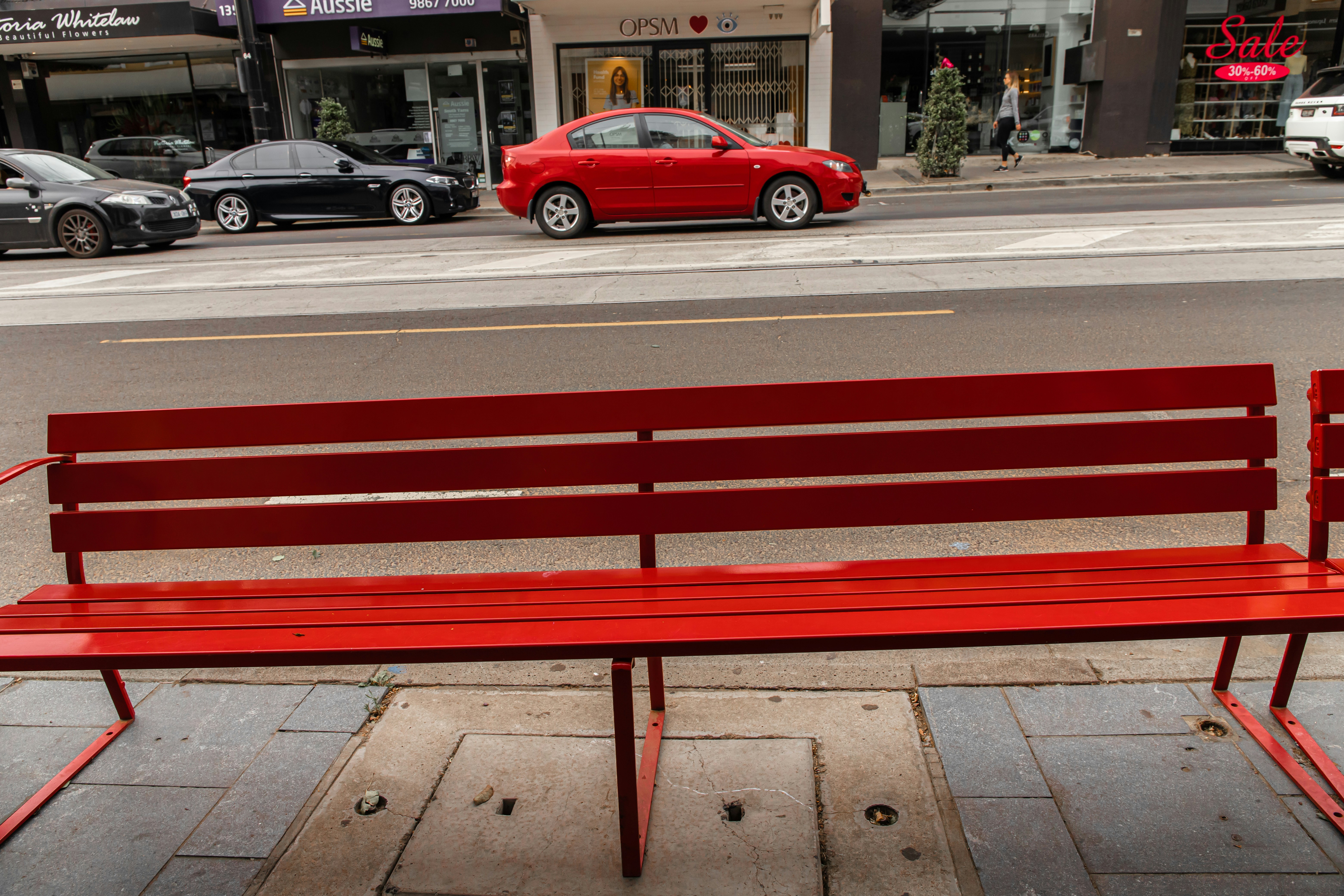 Red Bench Vista: Urban Street Scene with Quiet Car Line