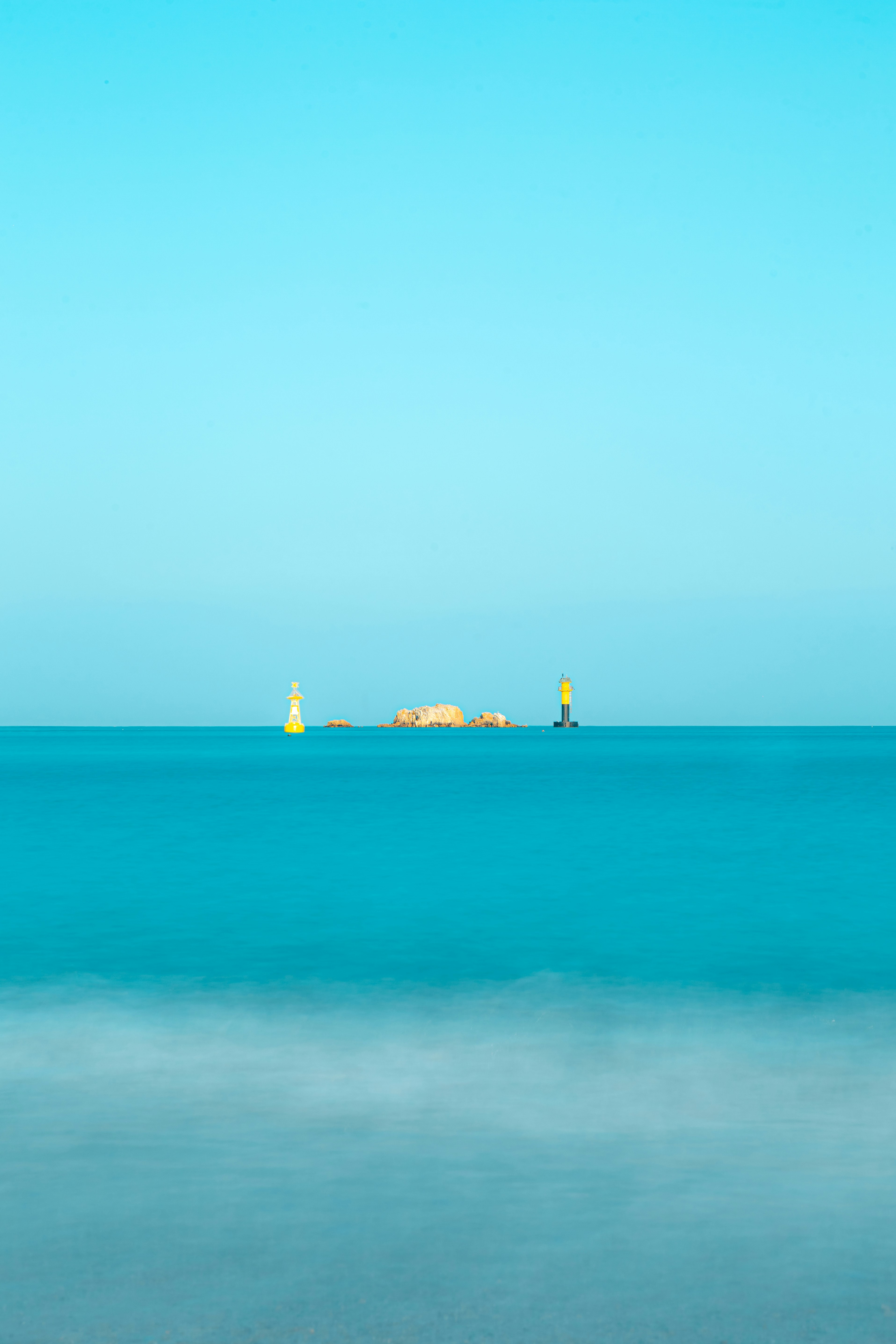 White and brown lighthouse on island surrounded by body of water during ...