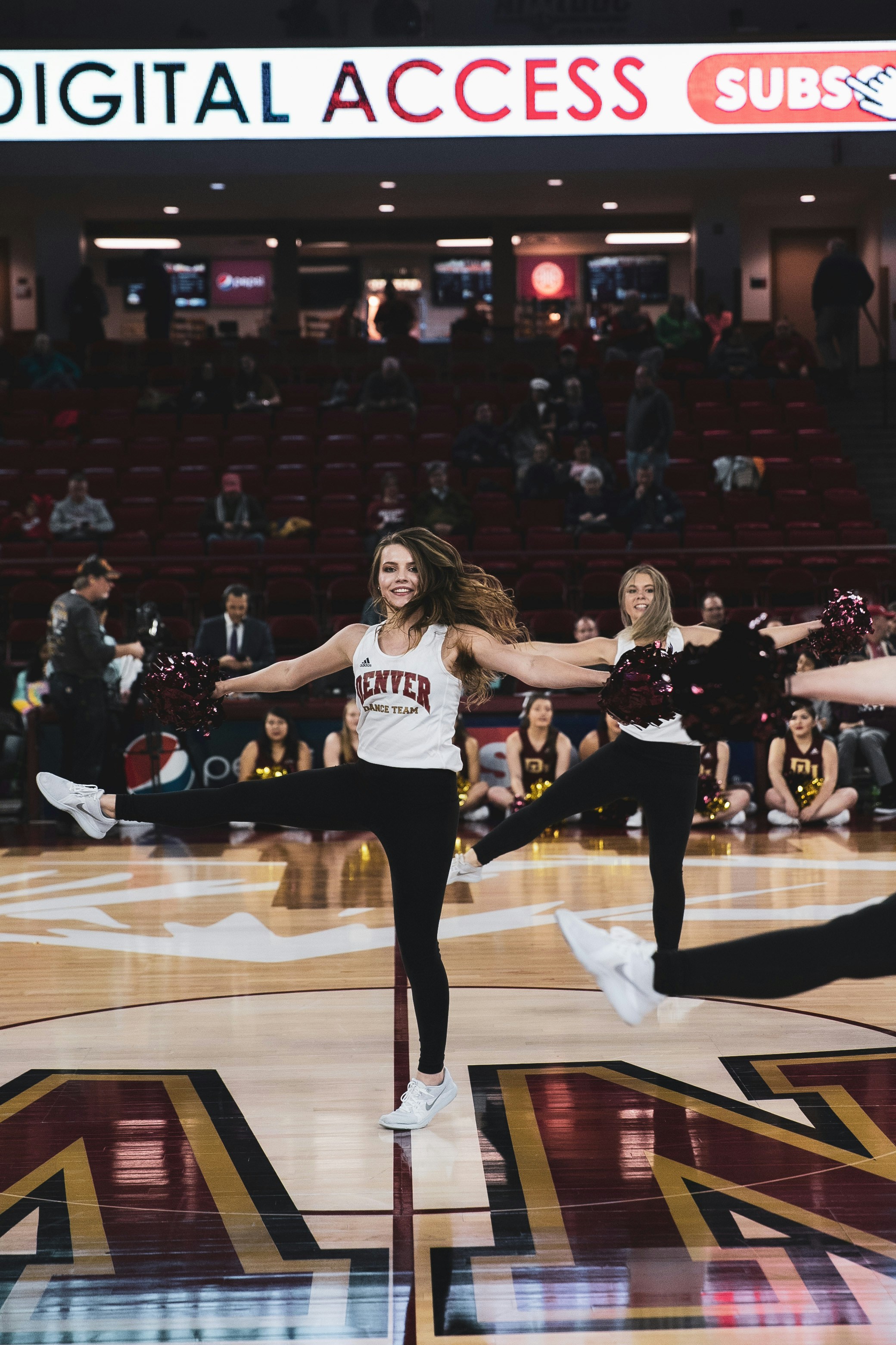 Midcourt Motion: Cheerful Soloist Leads a Wheel-Across in a Arena of Focus