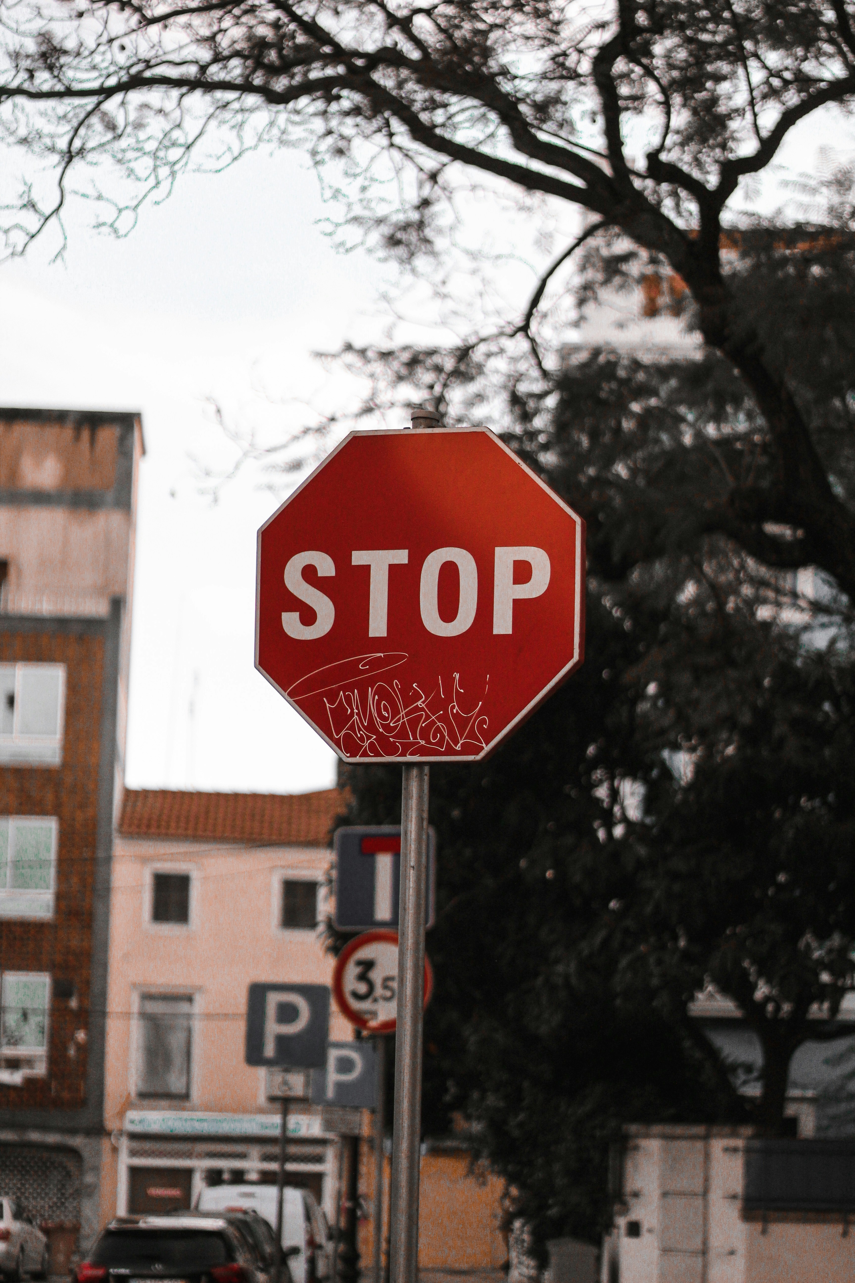Stop sign near brown building photo – Free Car Image on Unsplash