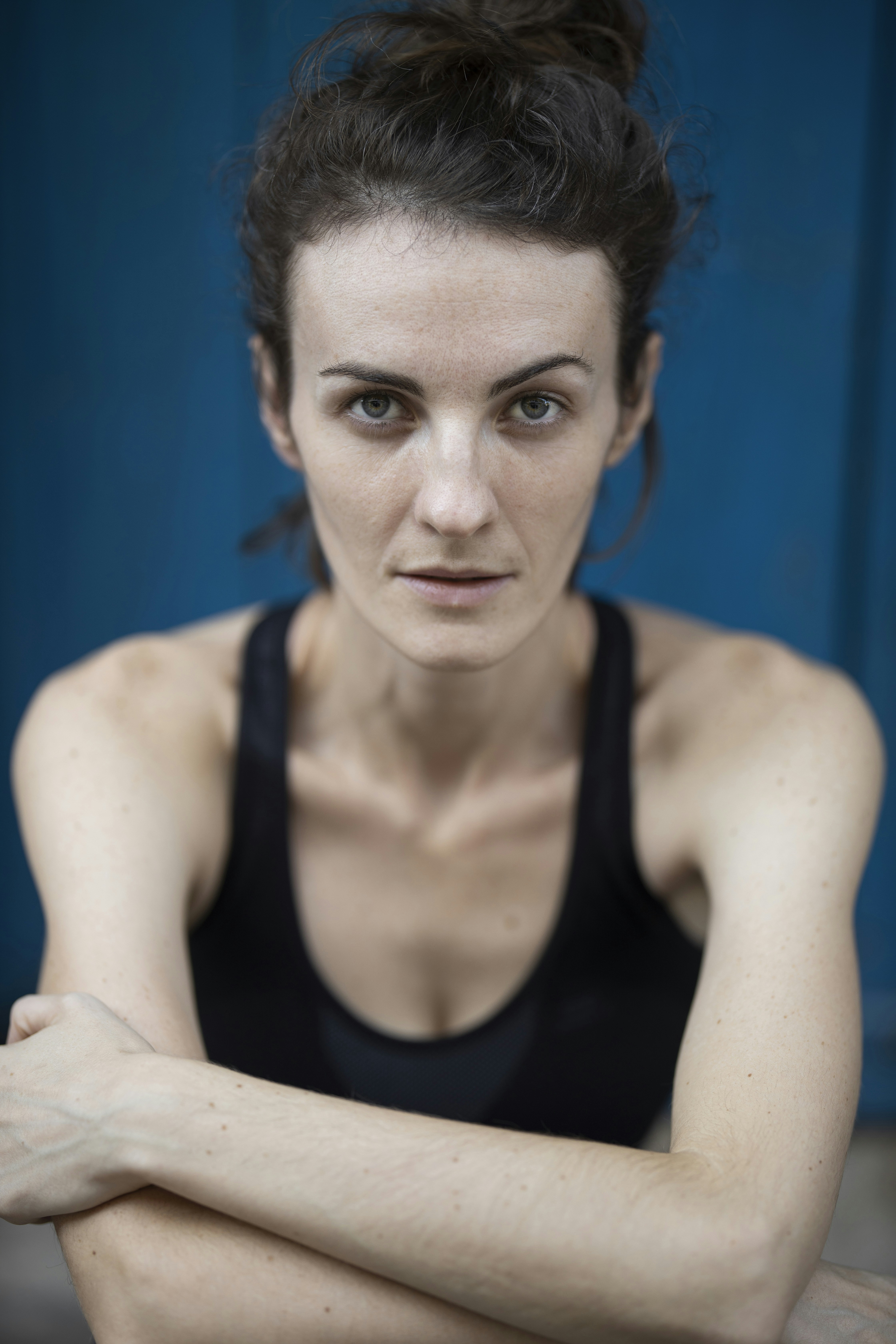 Direct Gaze, Quiet Strength: Portrait in Indigo Backdrop