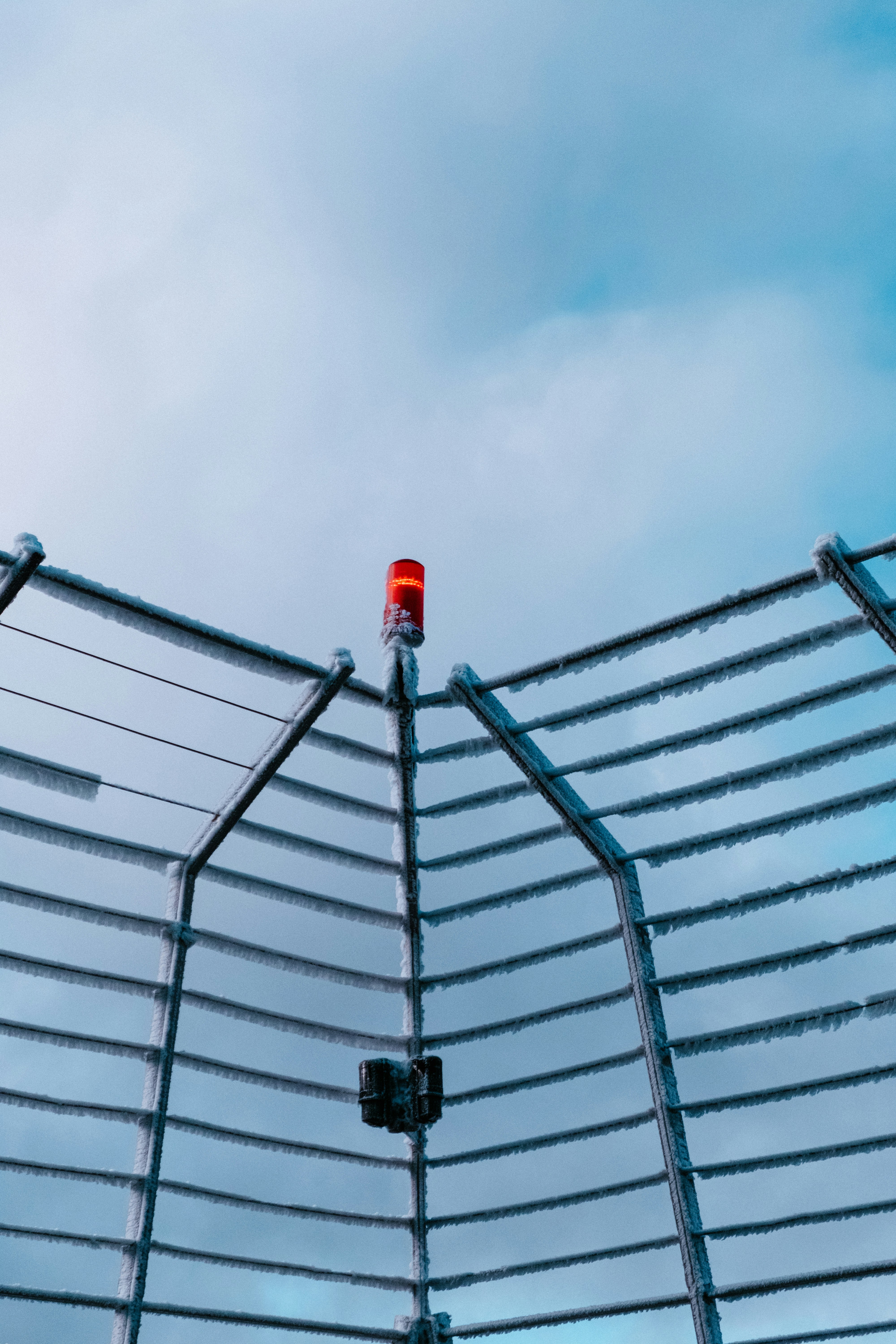 Red Beacon Above Frosted Rails: A Moment at the Barrier
