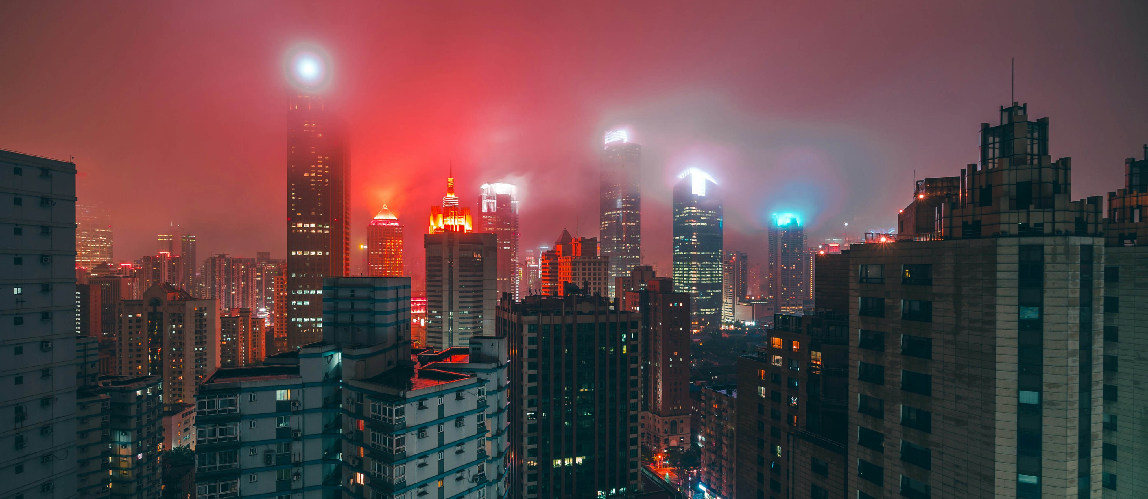 Neon Veil Over a Fog-Draped City Skyline