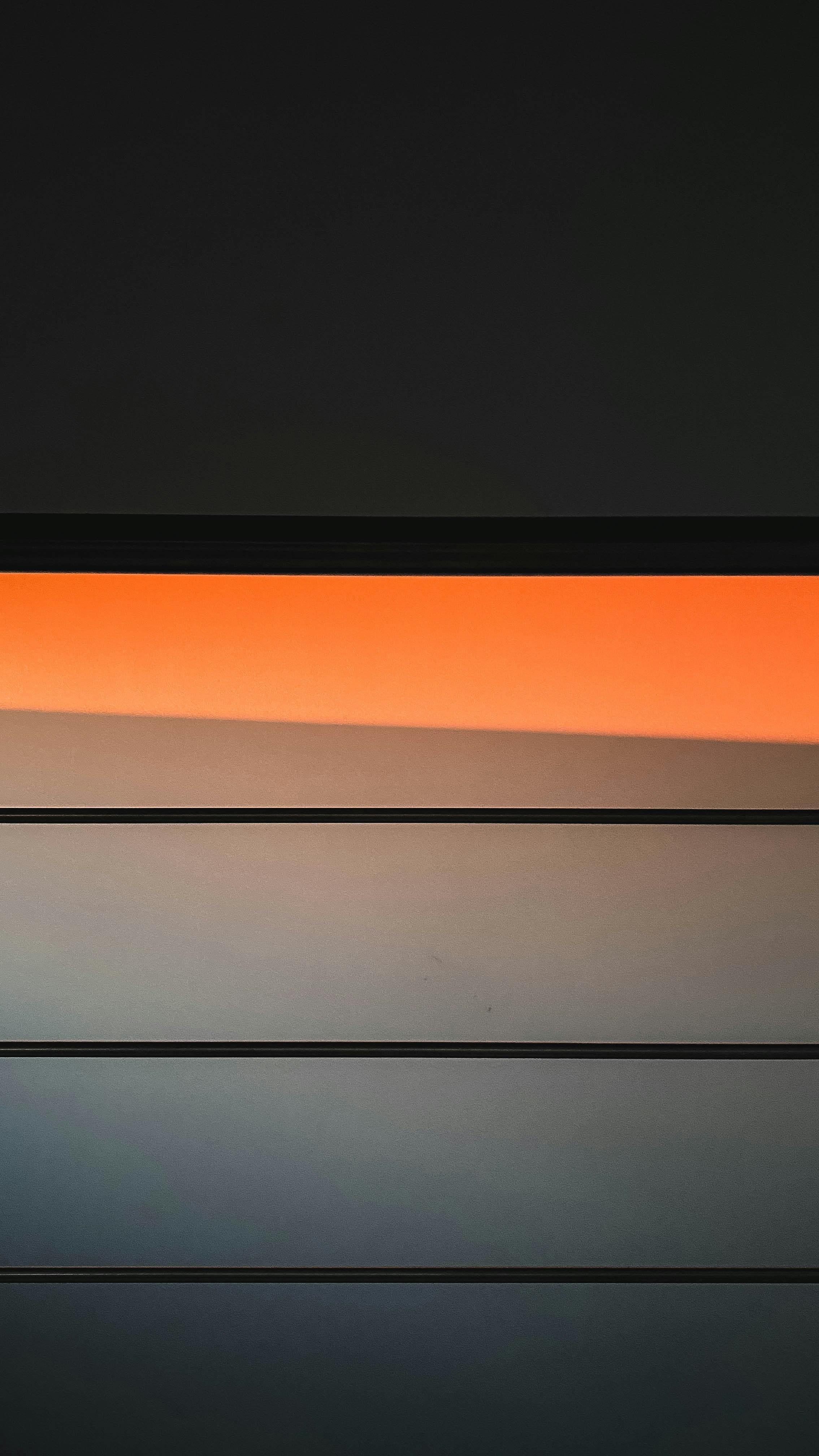 Abstract composition featuring horizontal lines with a gradient of colors transitioning from dark to a warm orange hue.