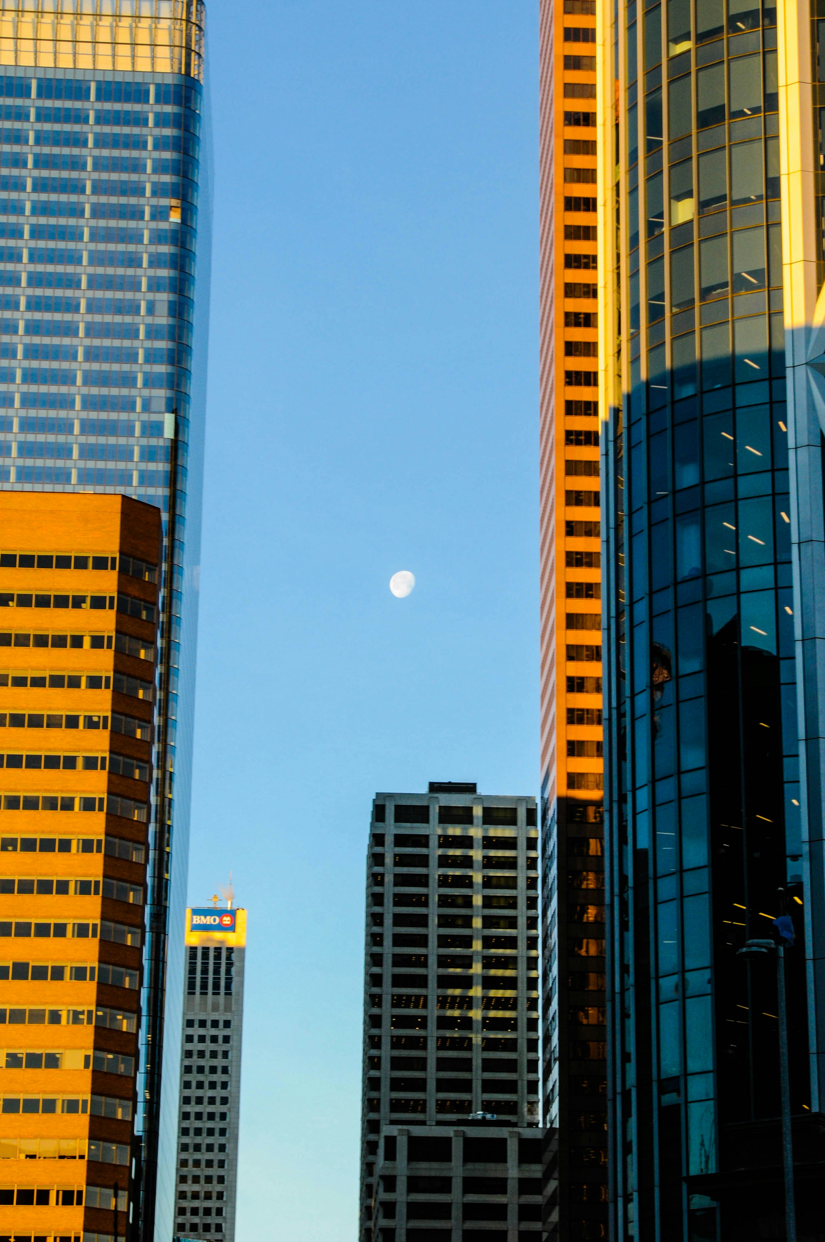 Moon Between Towers: Narrow Sky Above a City Canyon