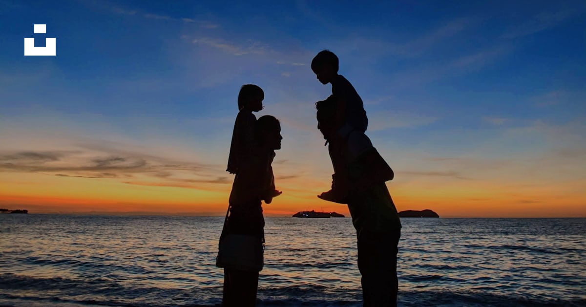 Silueta De Hombre Y Mujer Besándose Durante La Puesta Del Sol Foto