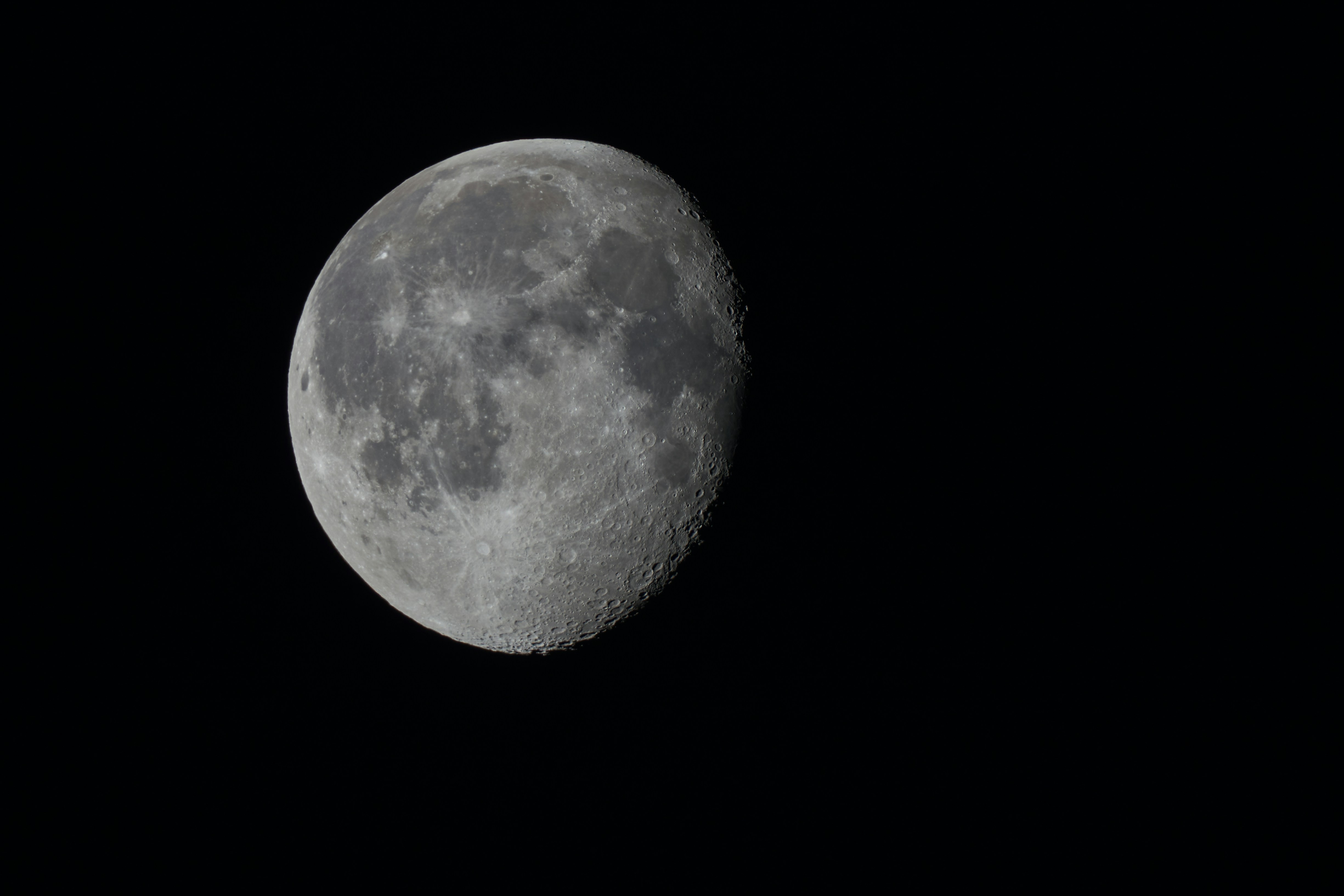 Crescent moon showcasing intricate surface details against a dark sky.