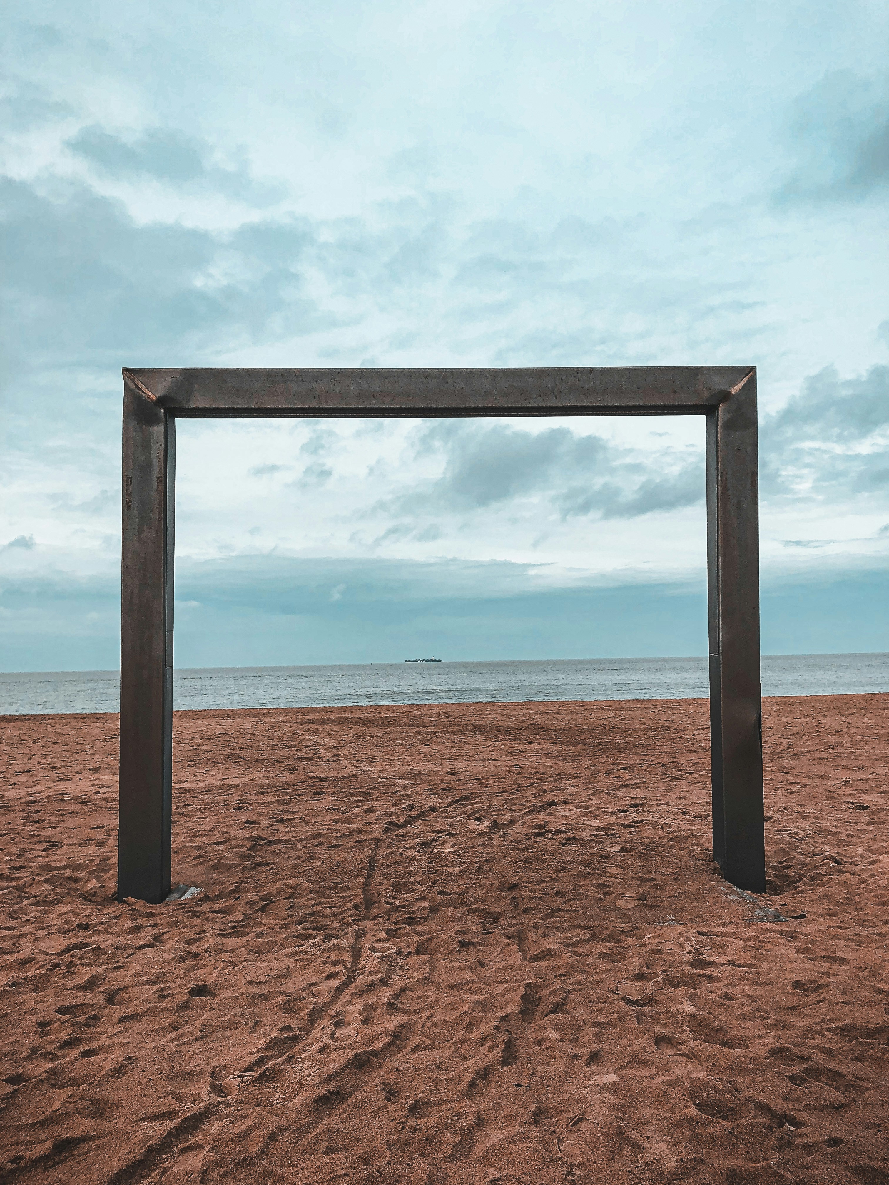 Horizon Doorway: A Rusted Frame Framing Sea and Sky