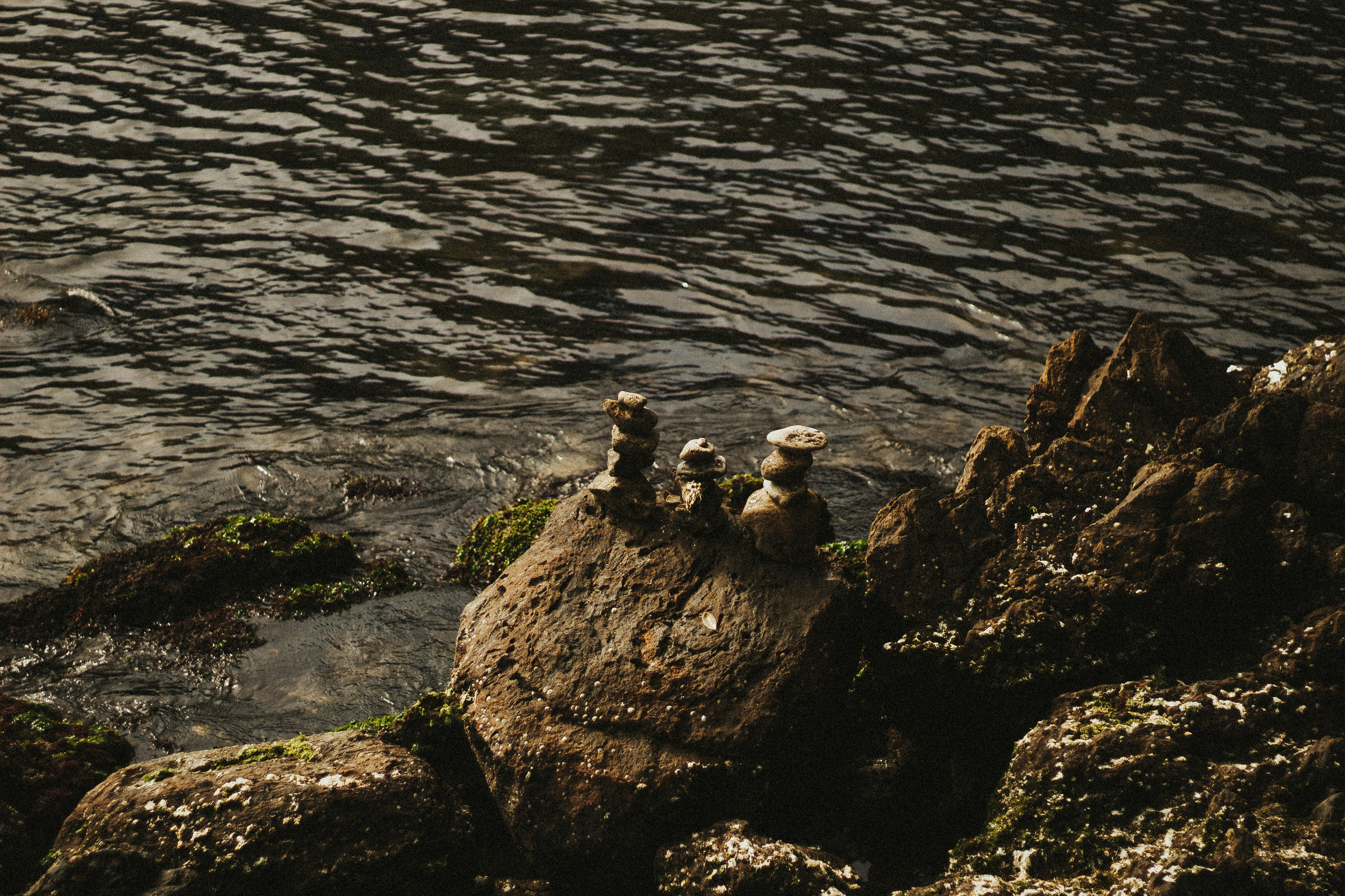 Tide-Kissed Cairns: Quiet Balance on the Weathered Rock