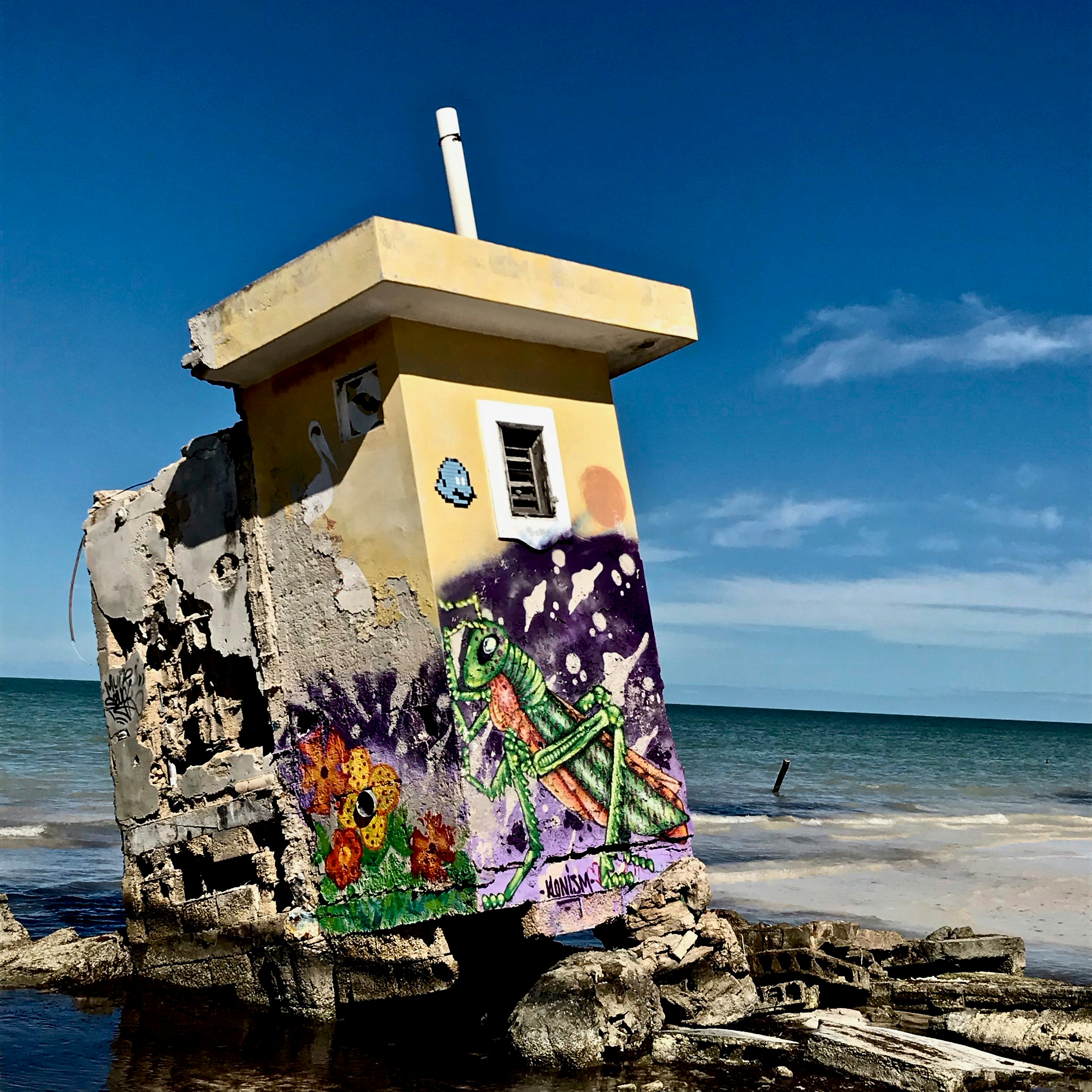 Sea-Washed Graffiti Keep: A Colorful Dragon Adorns a Crumbling Shoreline Tower