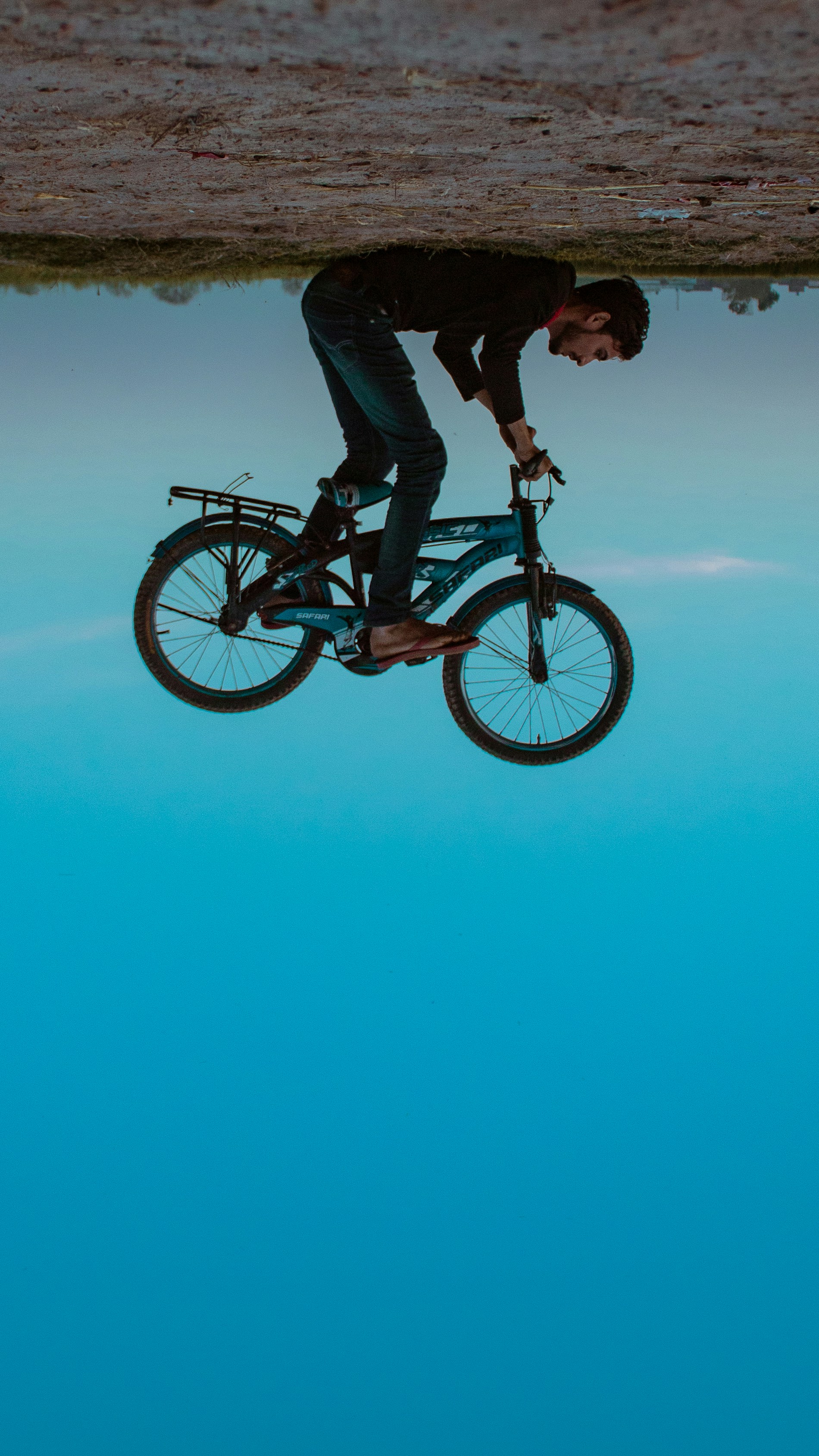 Blue Day Ride: Cyclist on a Dusty Trail