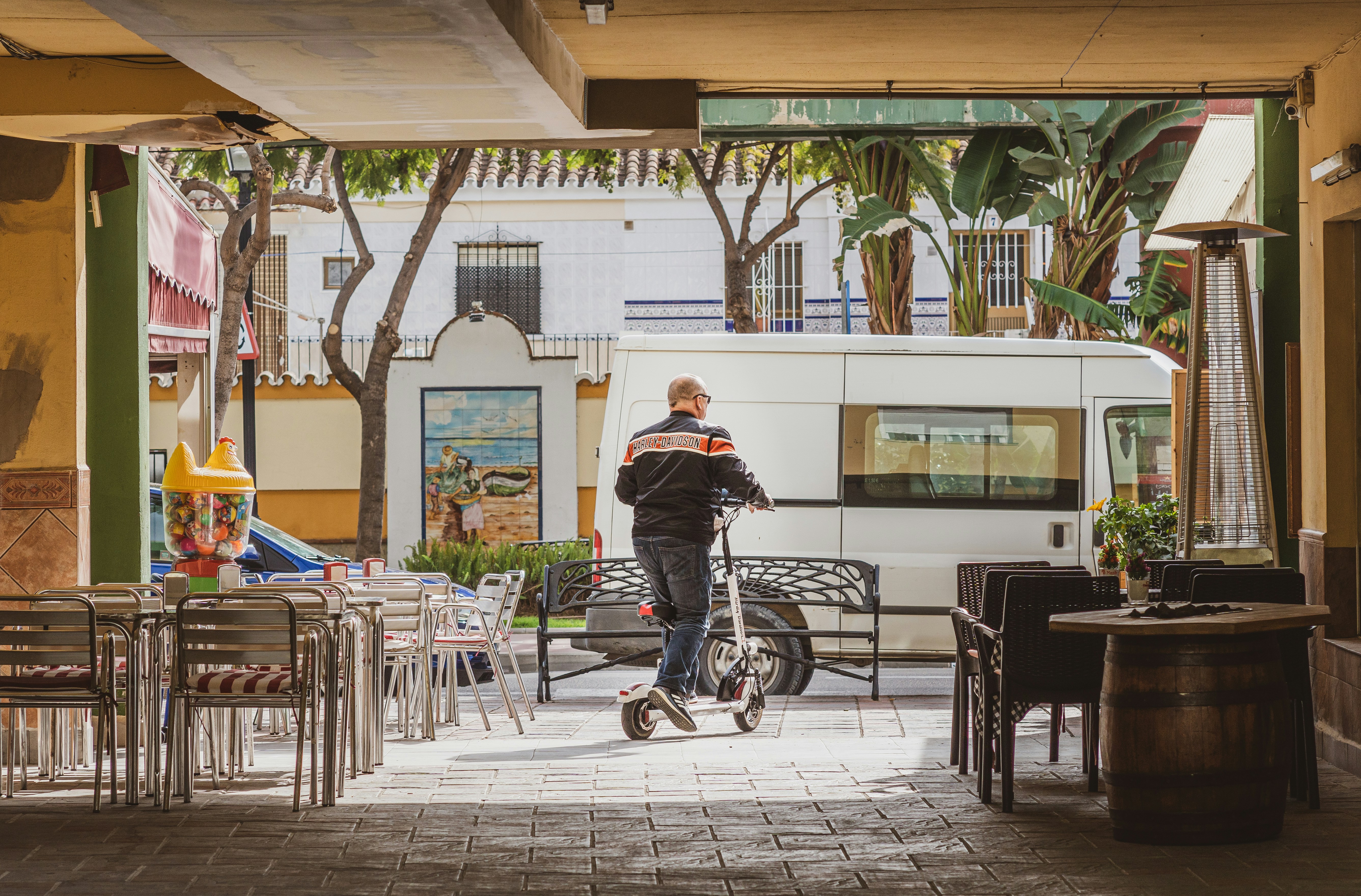 Under the Arcade: A lone rider crosses a sunlit courtyard