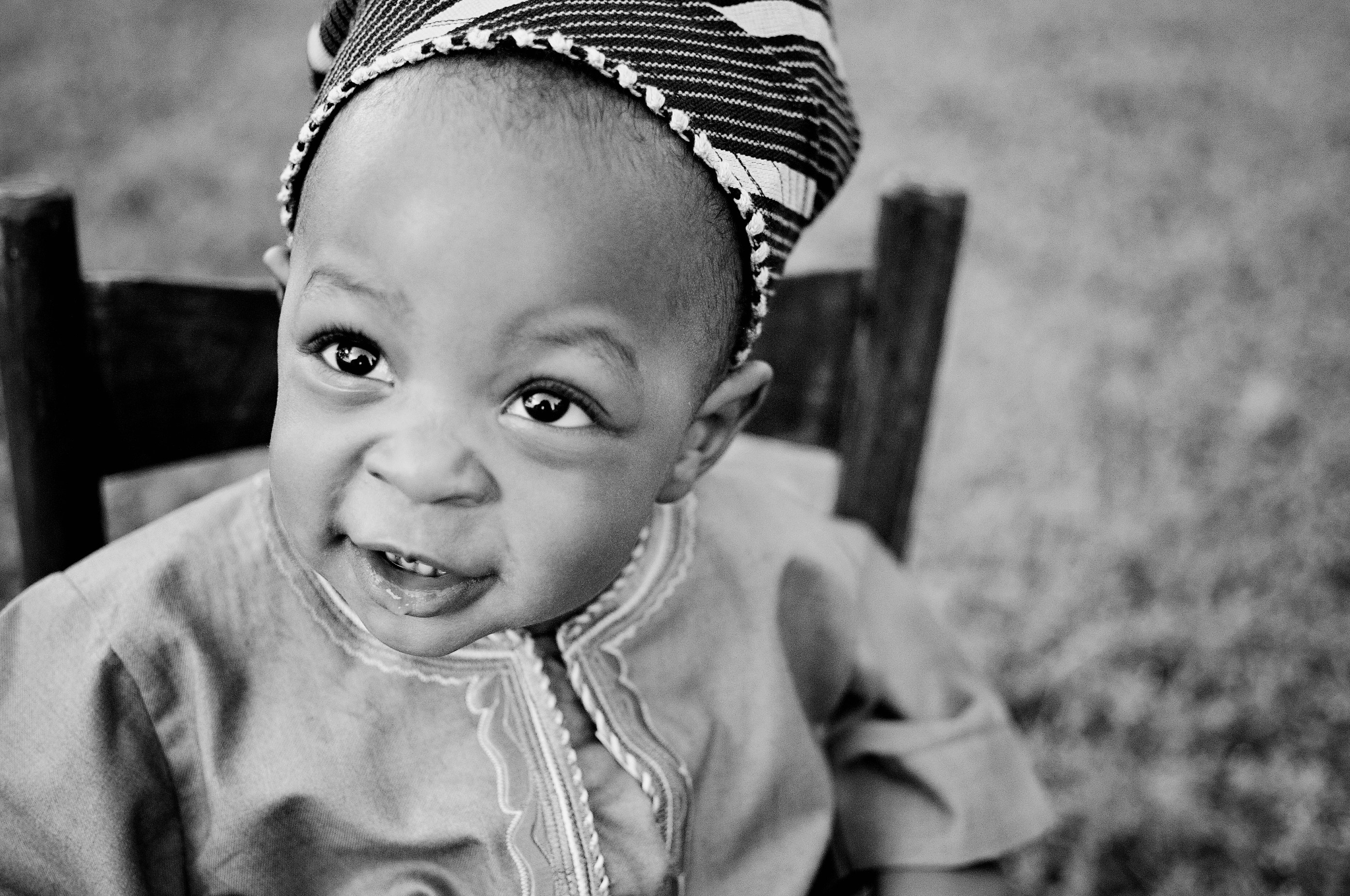 Grayscale photo of baby in white and black striped hat photo – Free ...