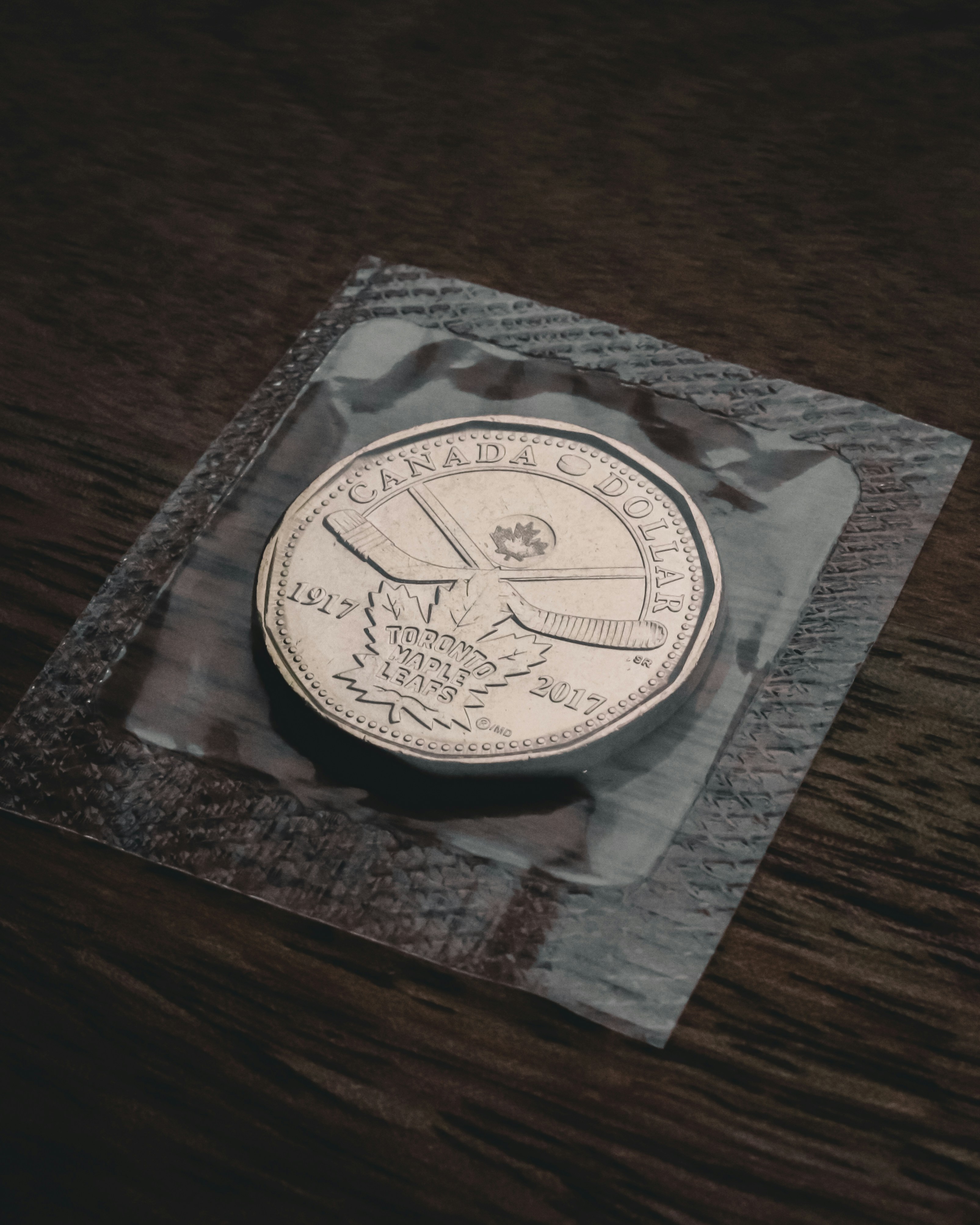 silver round coin in pack